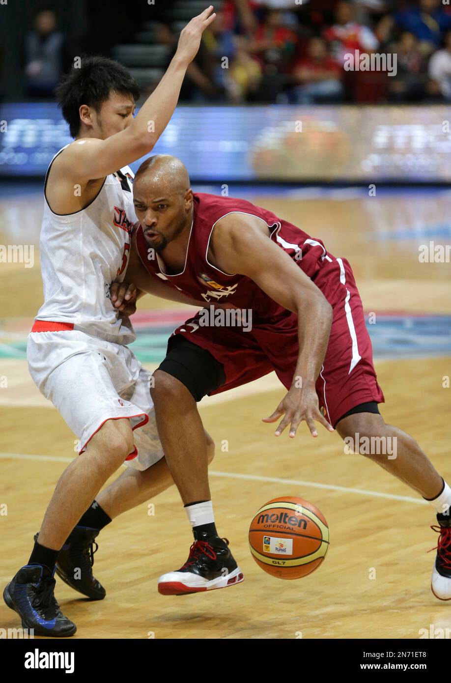 Qatar's Jarvis Hayes, right, dribbles past Japan's Daiki Tanaka during ...