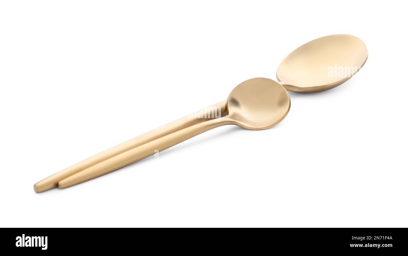 Elegant shiny golden spoons isolated on white Stock Photo - Alamy