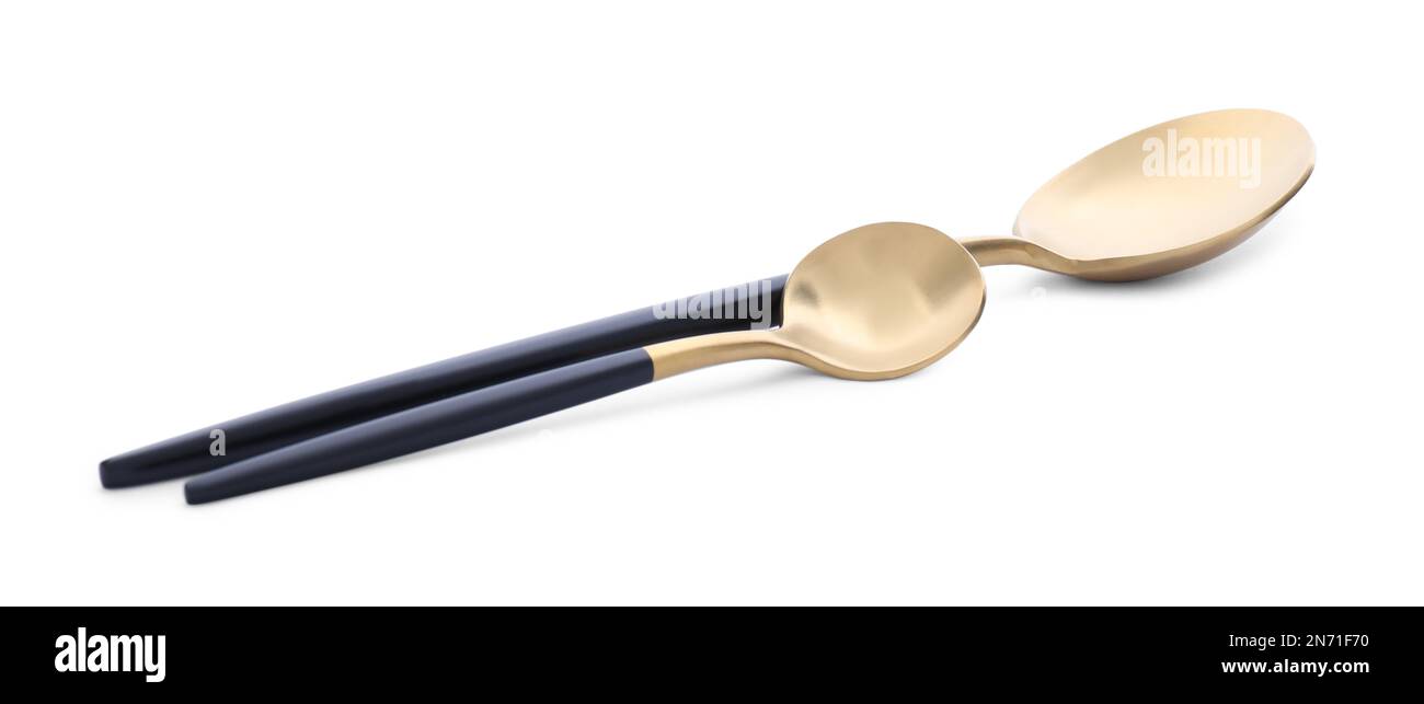 Elegant shiny golden spoons on white background Stock Photo - Alamy