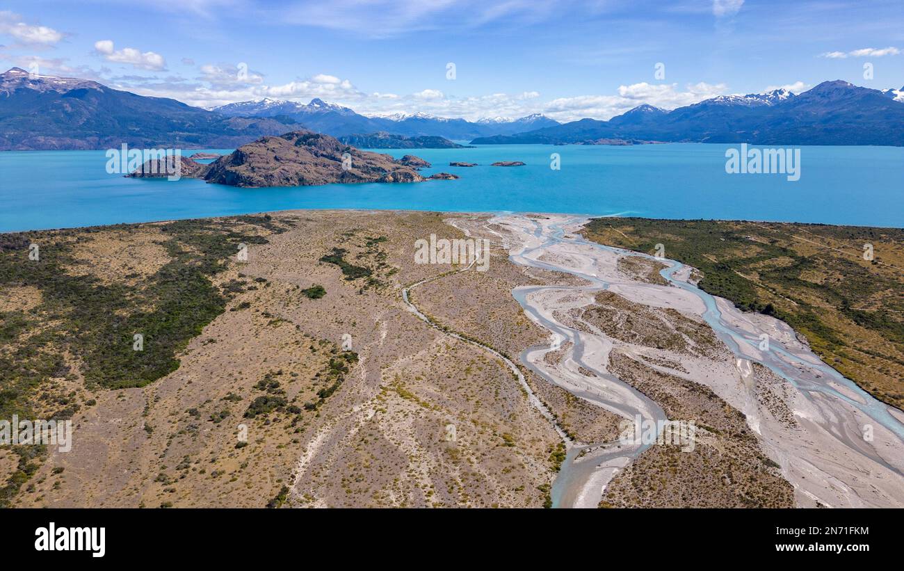 Aerial View of a creek flowing to the beautiful Lago General Carrera in ...