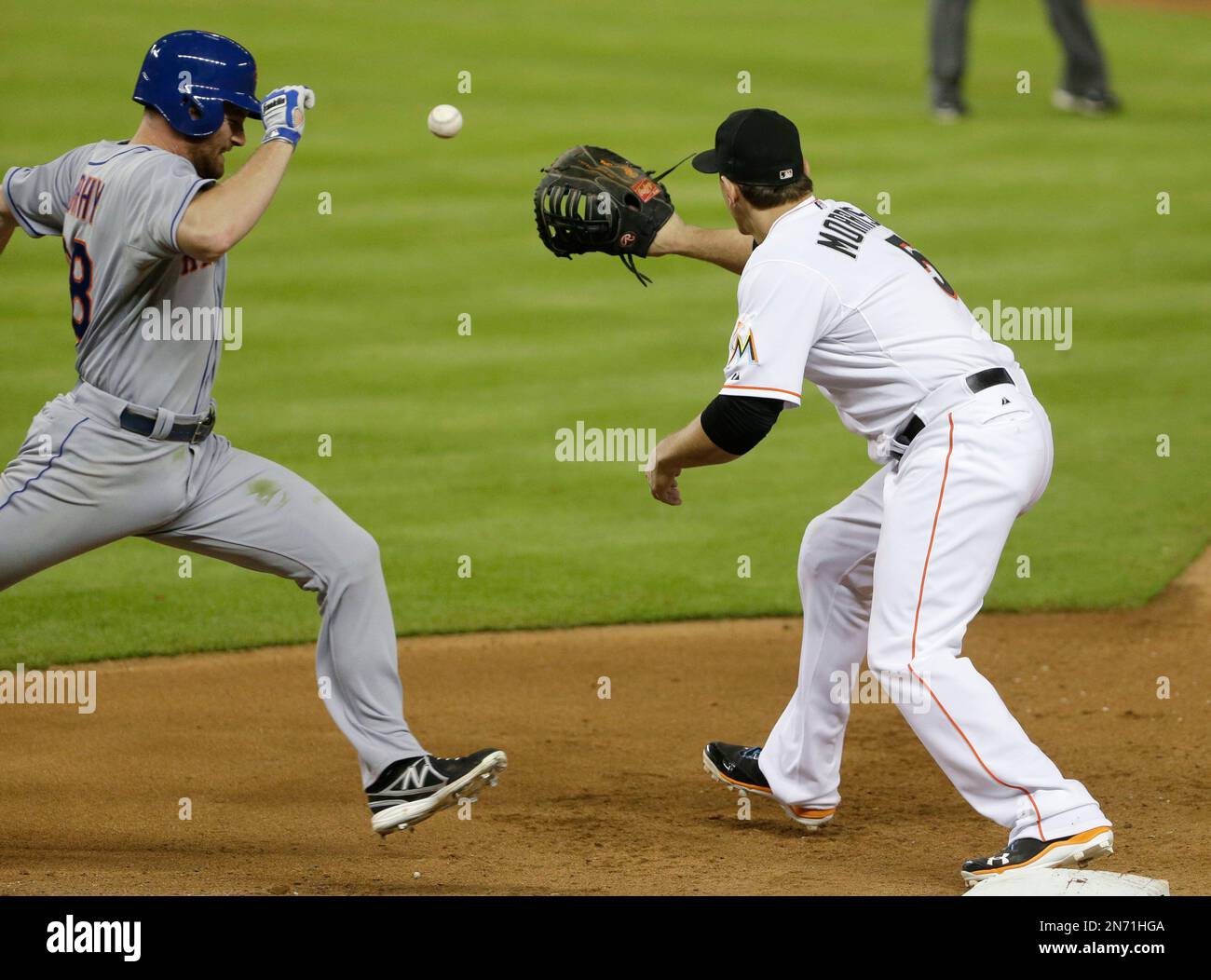 Miami Marlins first baseman Logan Morrison, right, waits for the throw ...