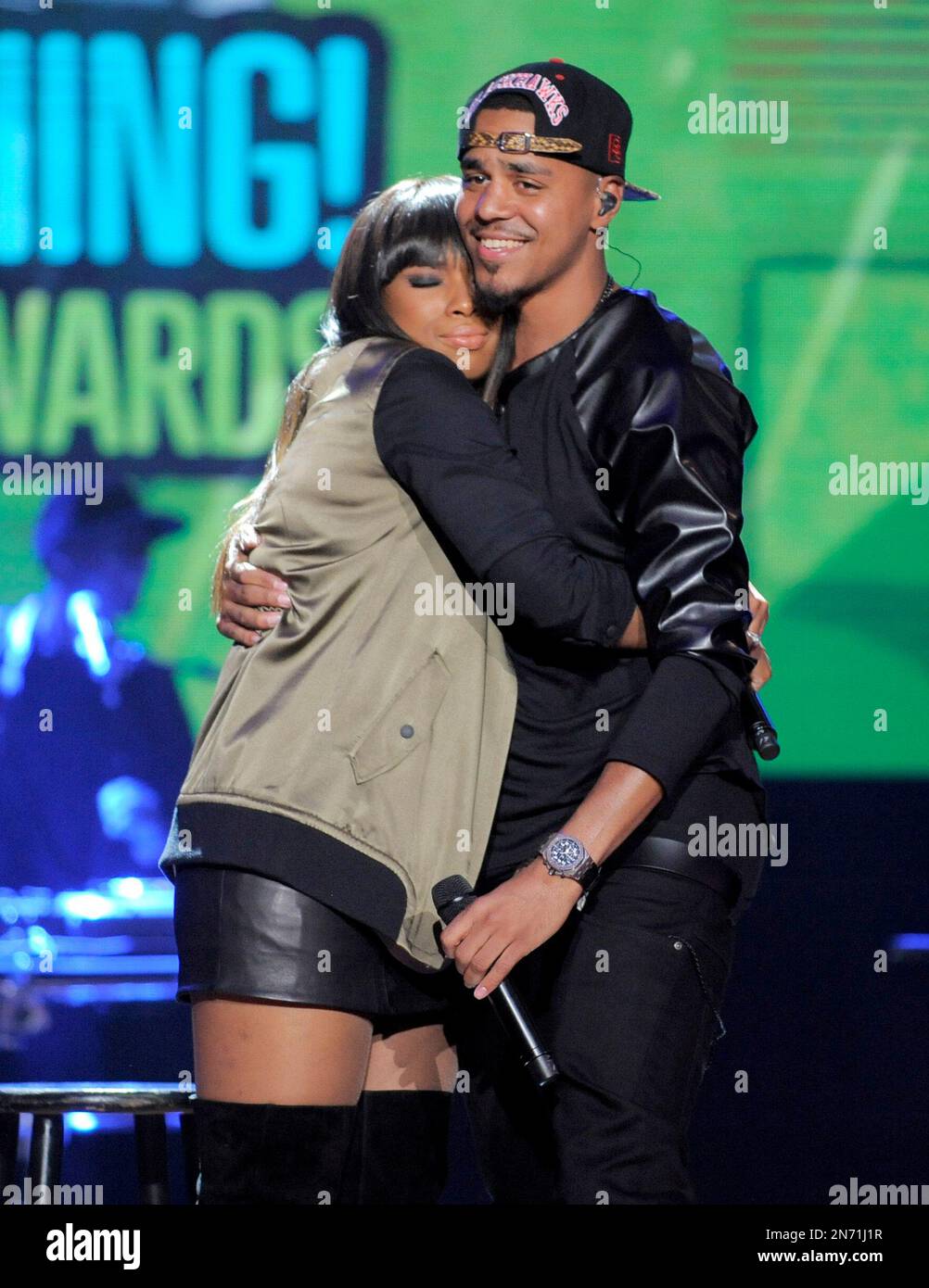 Jennifer Hudson, left, and J. Cole hug on stage at the Do Something ...