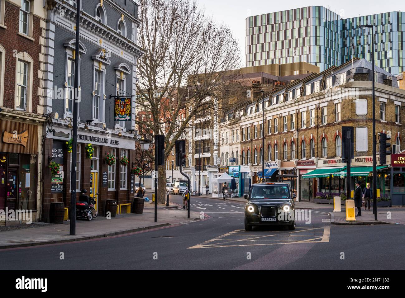 Black cab driving on King's Cross Road, London, England, UK Stock Photo ...