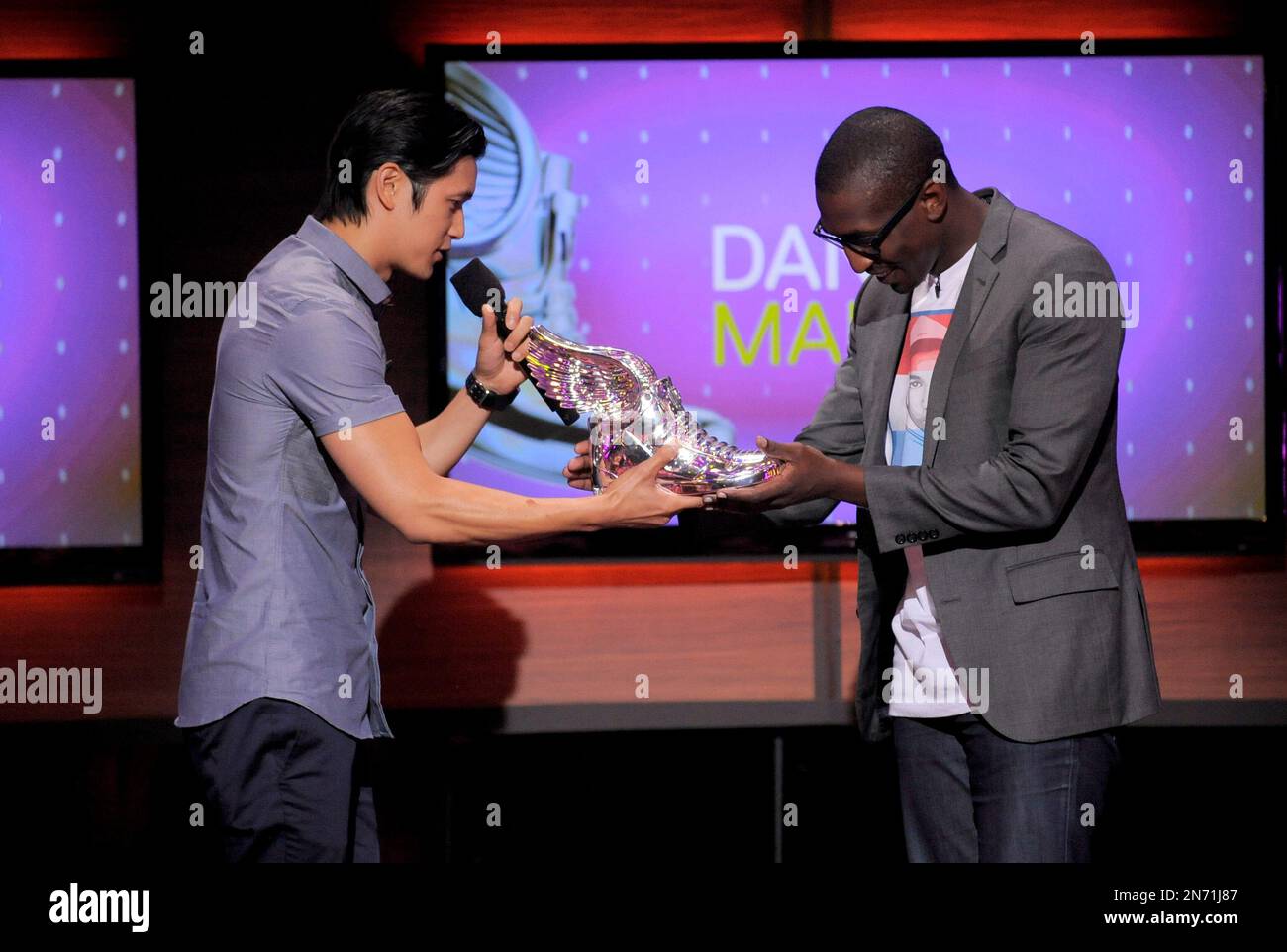 Harry Shum Jr., left, presents an award to nominee Daniel Maree at the Do Something Awards at ...