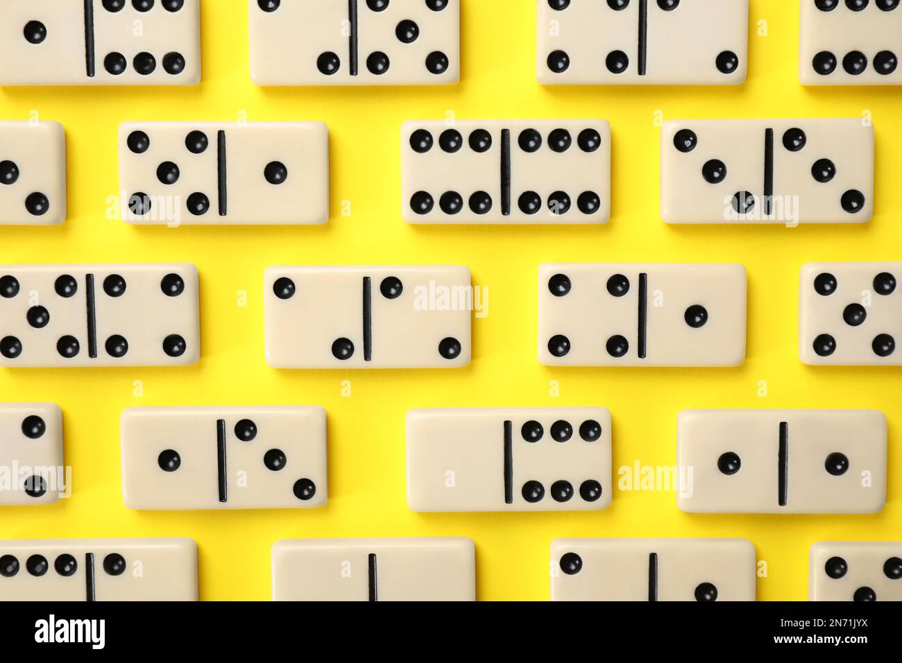 Classic domino tiles on yellow background, flat lay Stock Photo - Alamy