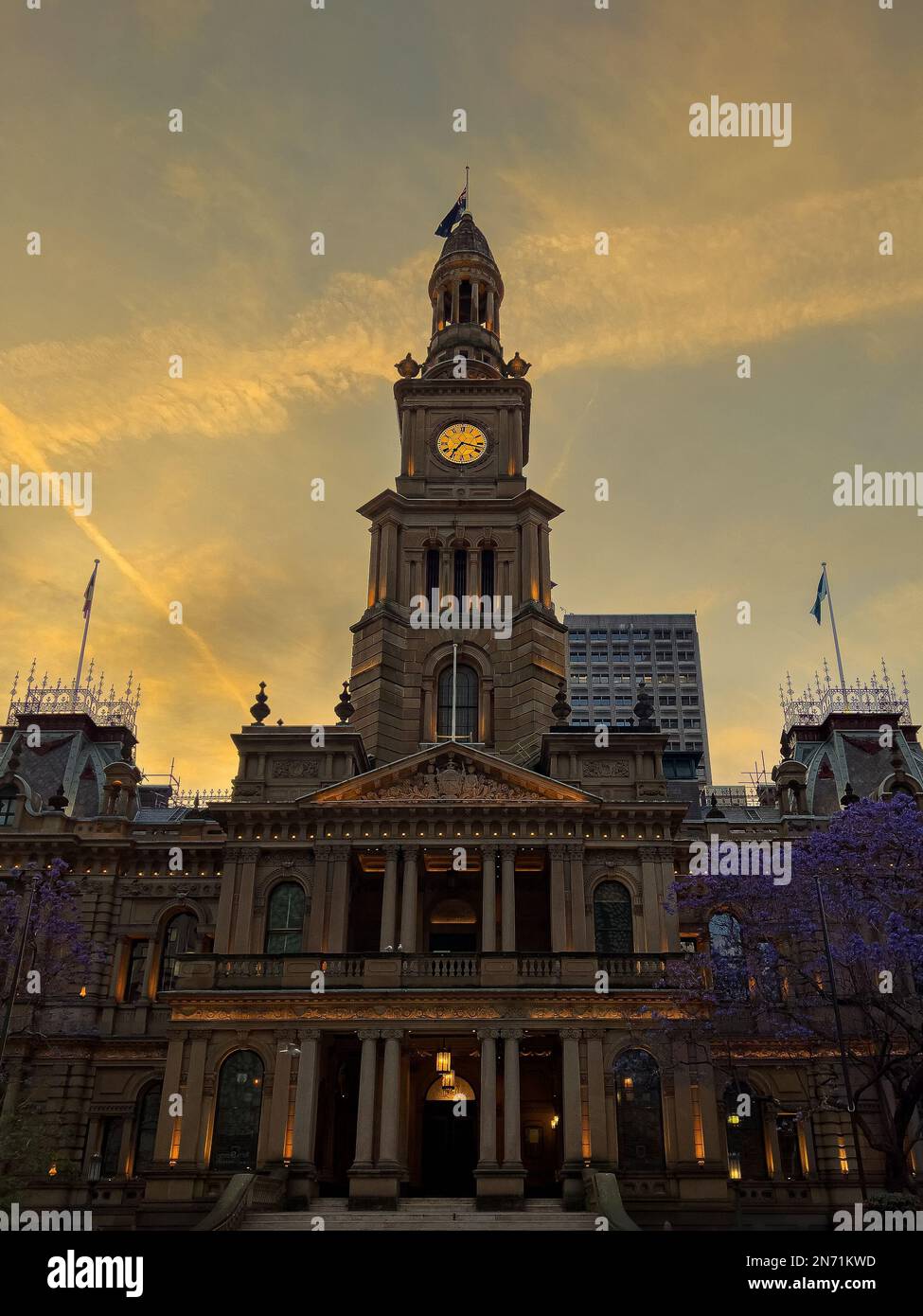 A closeup of illuminated clock tower of historical Town Hall of Sydney ...
