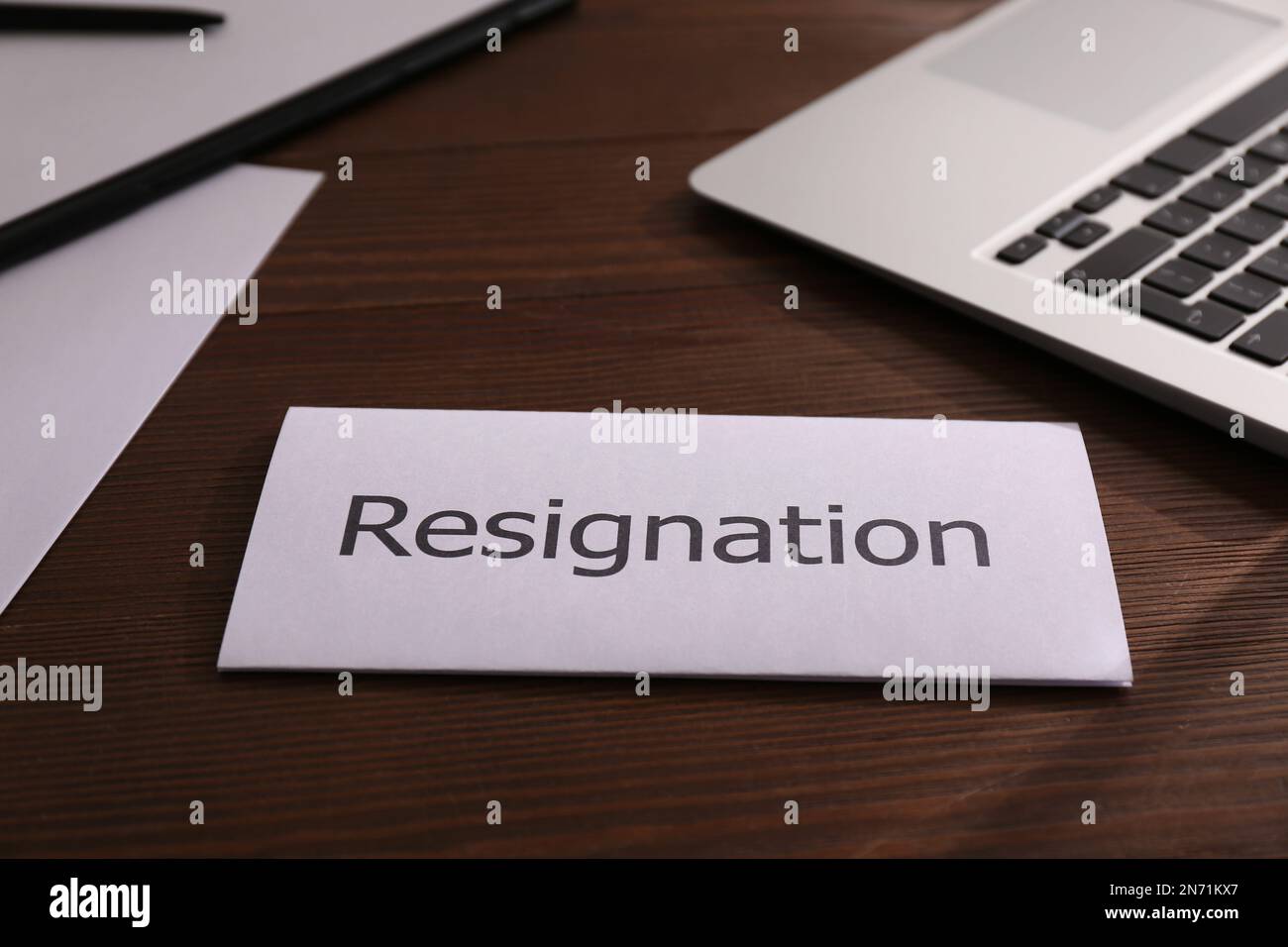 Resignation letter on wooden table in office Stock Photo - Alamy