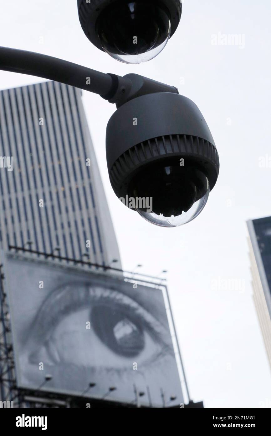 Security cameras are mounted on the side of a building overlooking an ...