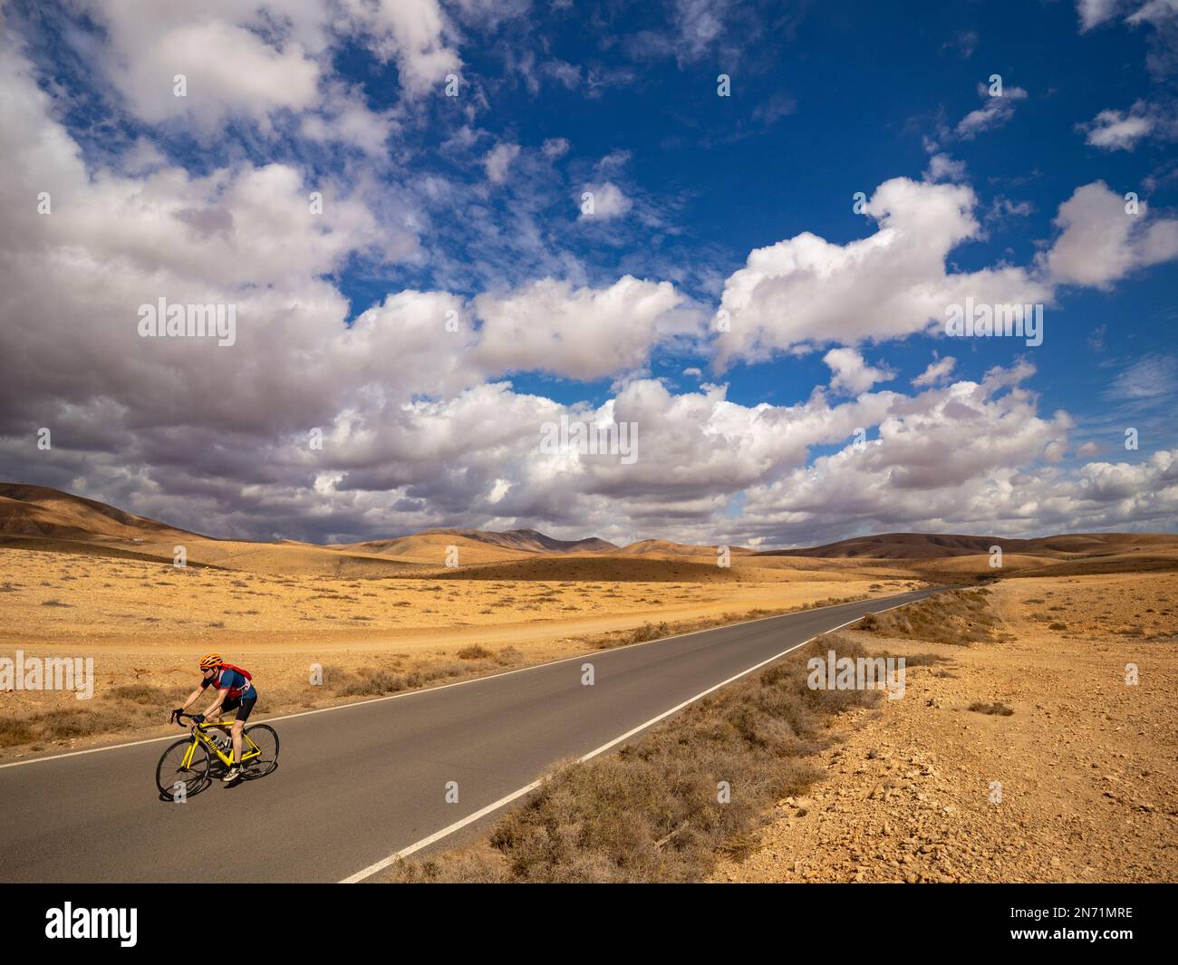 Road cyclist on side road in the central hill country of Fuerteventura ...