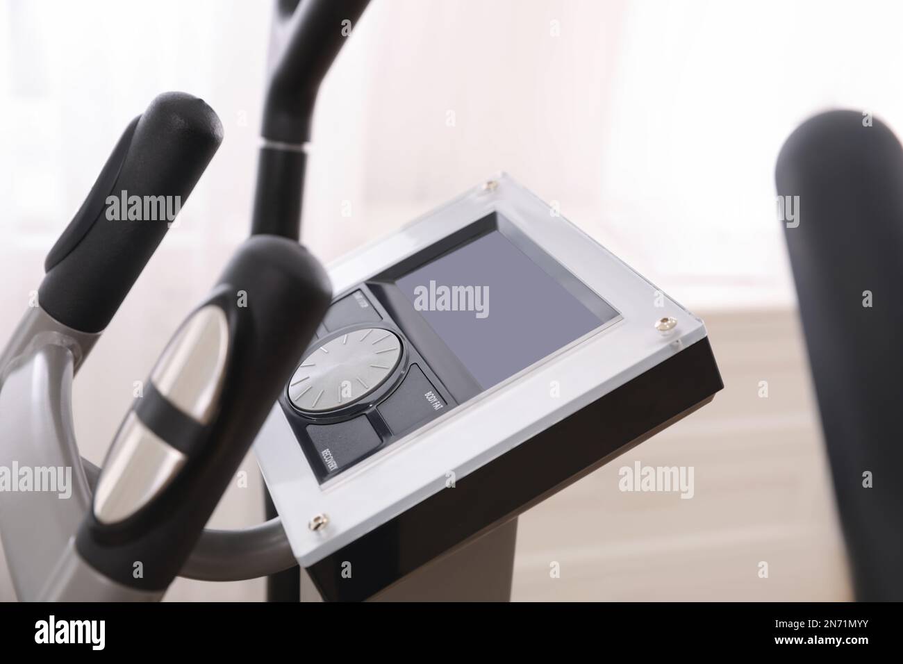 Control panel of modern elliptical machine cross trainer on blurred ...