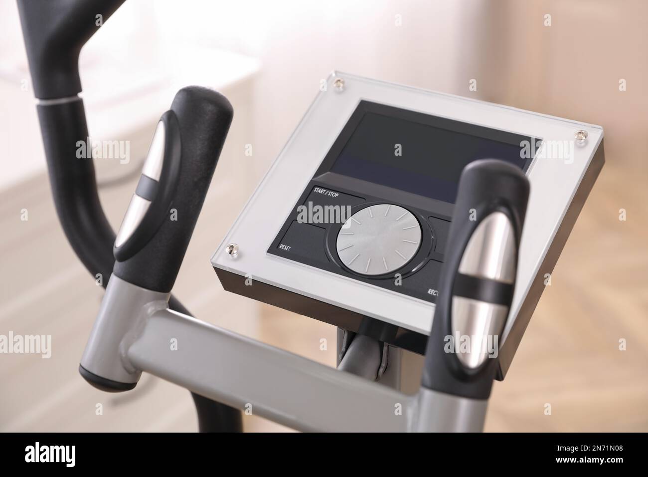 Control panel of modern elliptical machine cross trainer on blurred ...