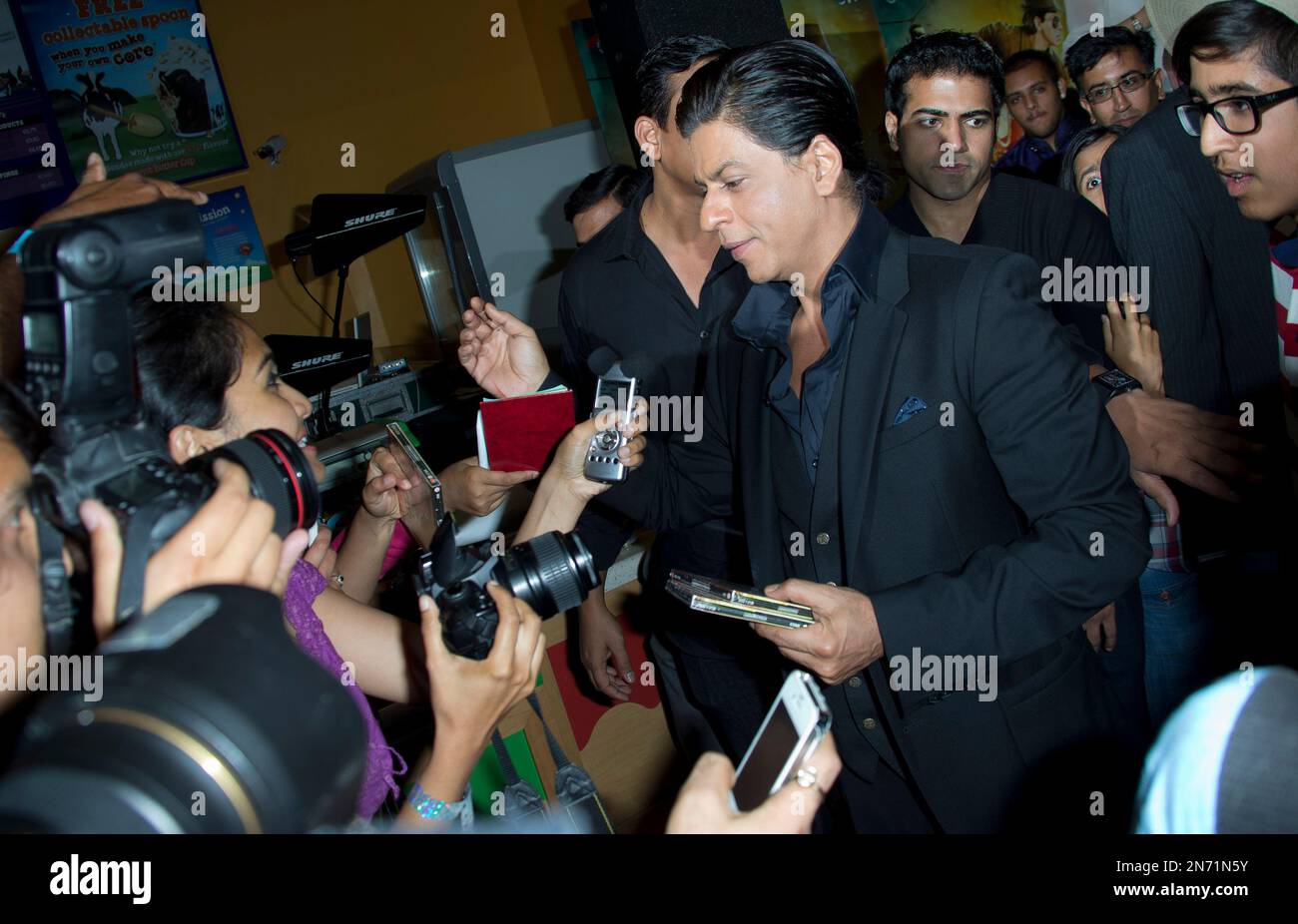 Bollywood actor Shah Rukh Khan signs autographs as he attends the UK ...