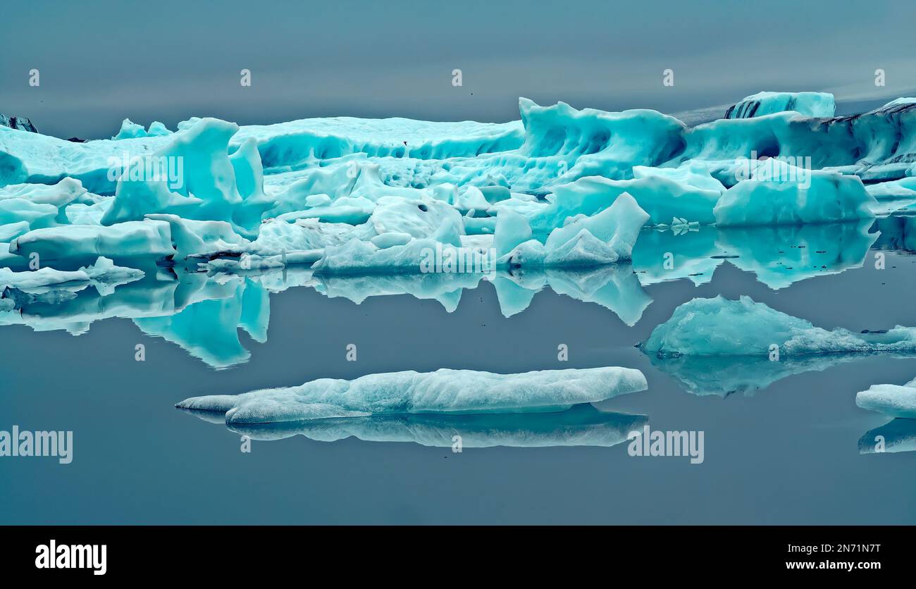 Reflections of crystal blue and white ice floes in black dark glassy ...