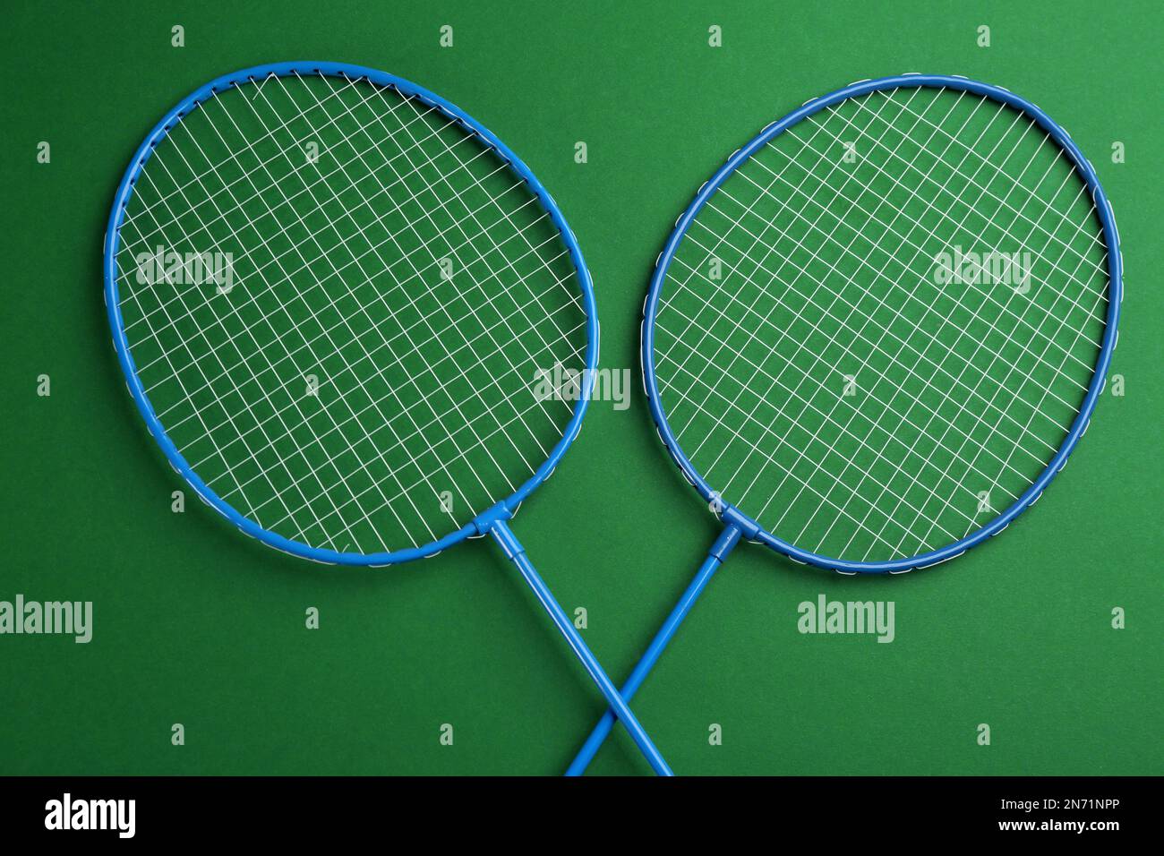 Badminton rackets on green background, flat lay Stock Photo - Alamy