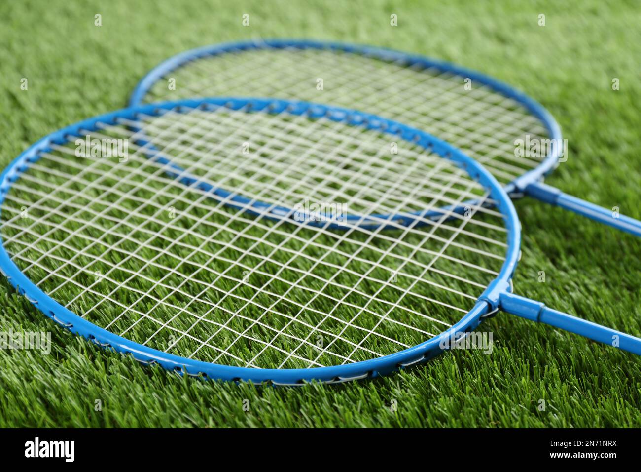 Badminton rackets on green grass outdoors, closeup Stock Photo - Alamy
