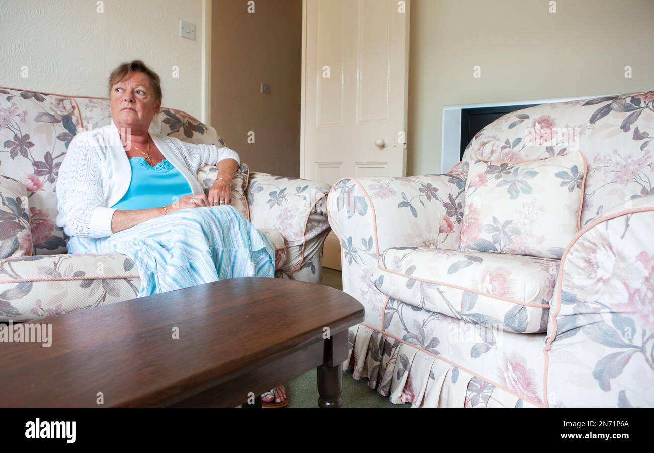 Retirement: Home Alone. A solitary senior lady sitting looking in ...