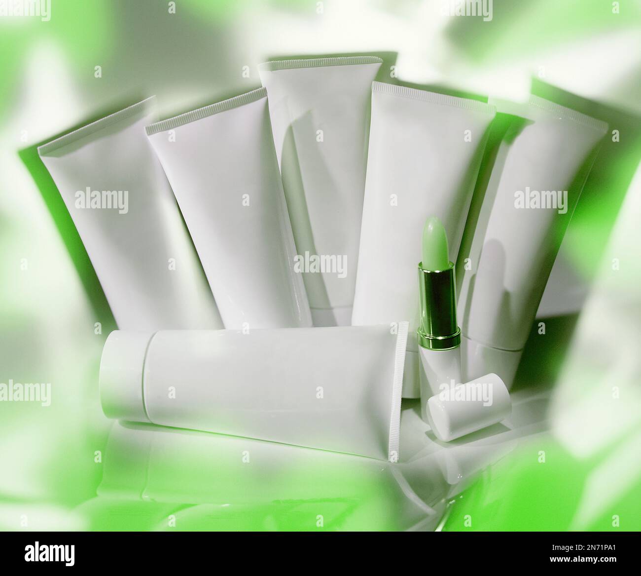 Group of private label cosmetic tubes in reflective concept studio ...