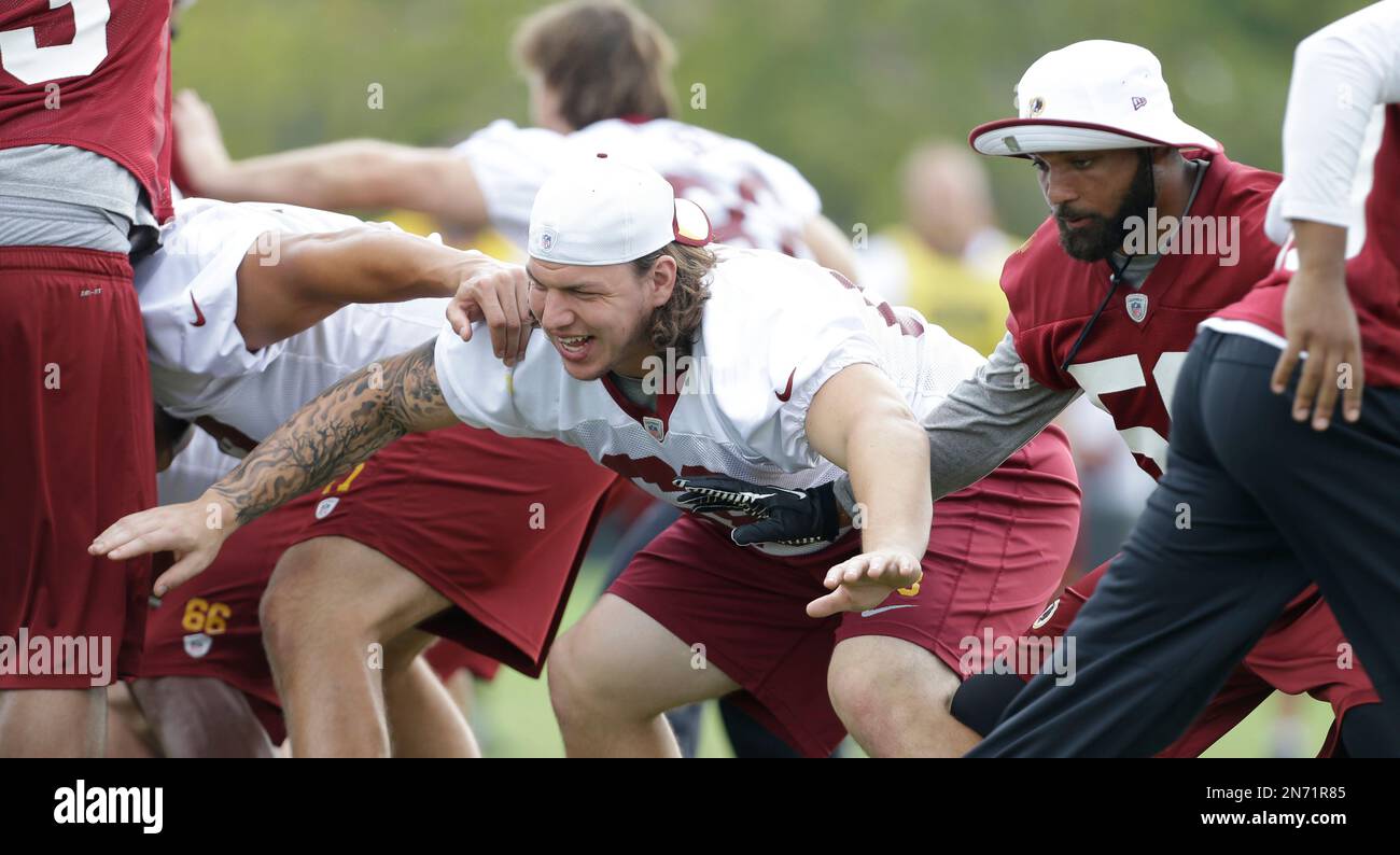 Washington Redskins tackle Tom Compton, center, and linebacker Perry ...