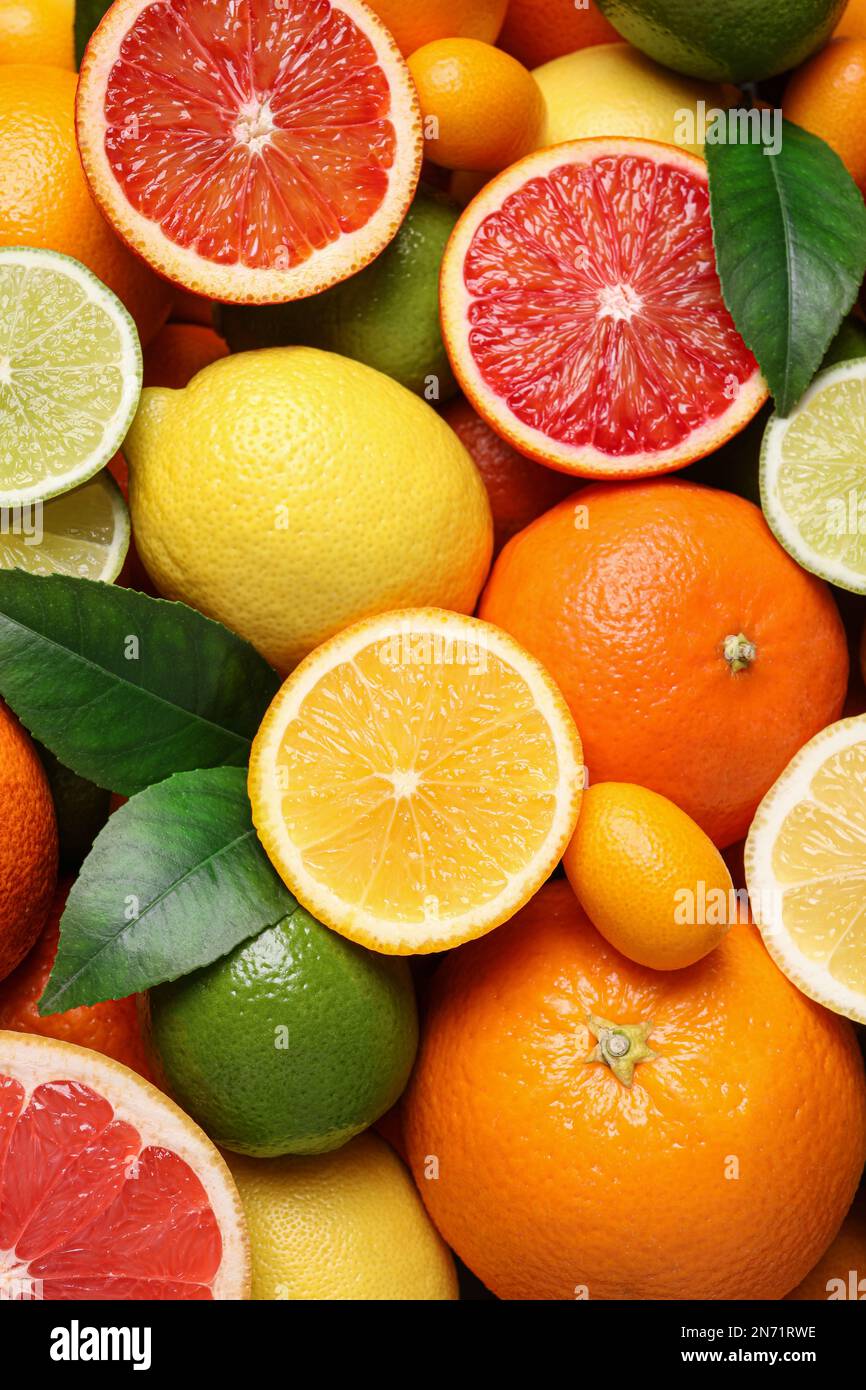 Different ripe citrus fruits as background, closeup Stock Photo - Alamy