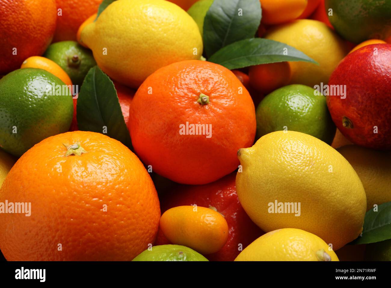 Different ripe citrus fruits as background, closeup Stock Photo - Alamy