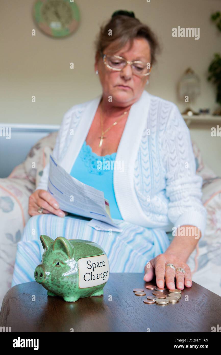 Retirement: Counting the Pennies. A senior lady balancing her rising ...