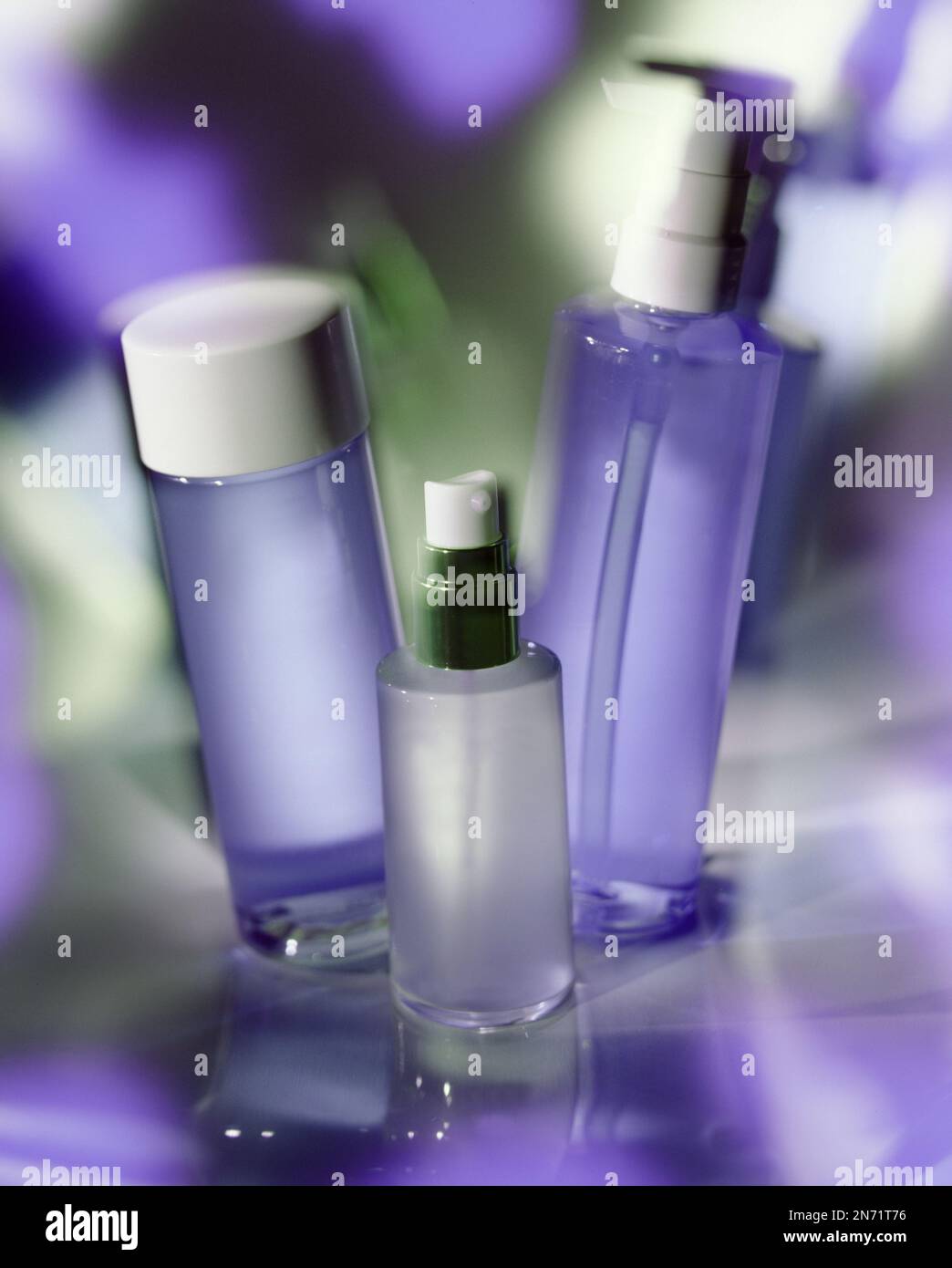 Group of private label cosmetic tubes and jars in reflective concept ...