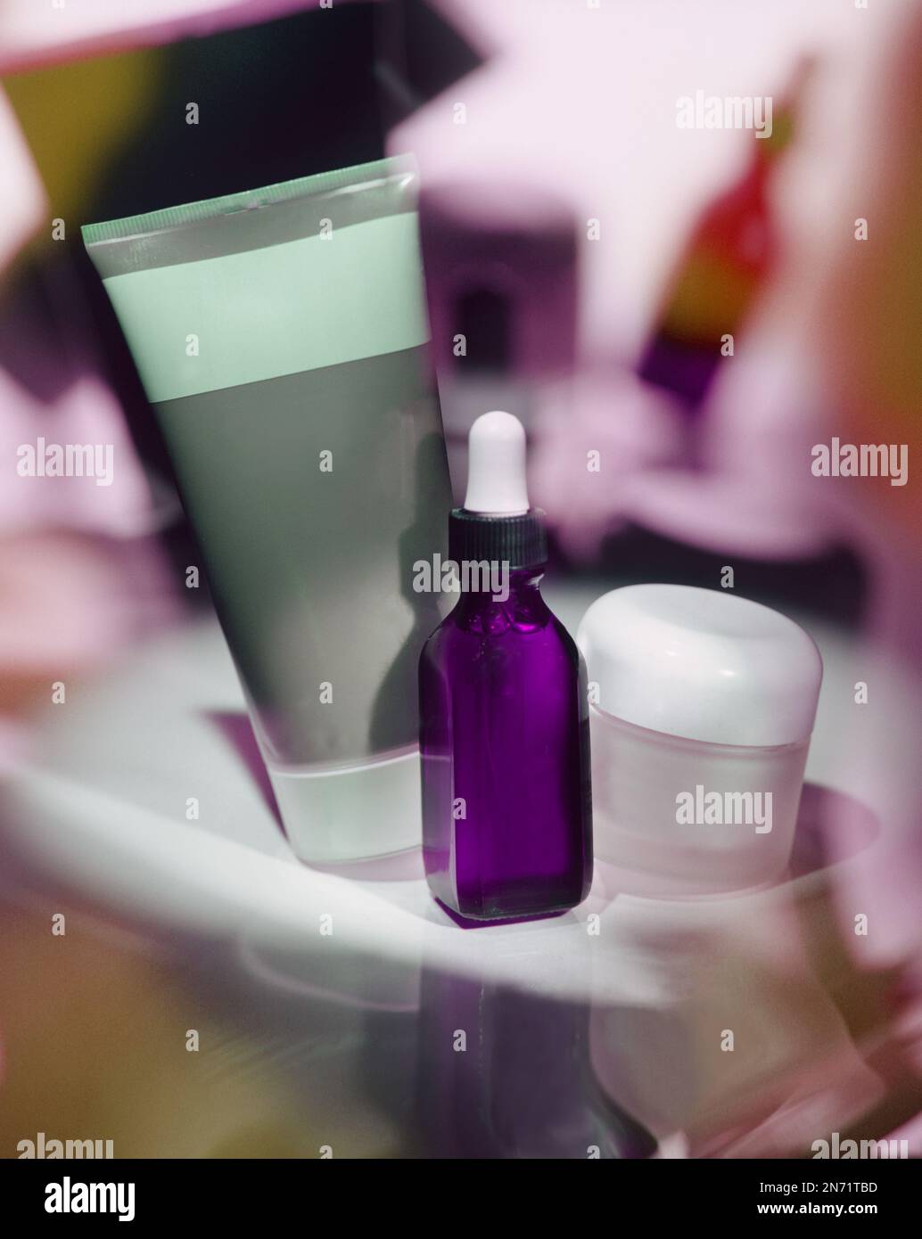 Group of private label cosmetic tubes and jars in reflective concept ...