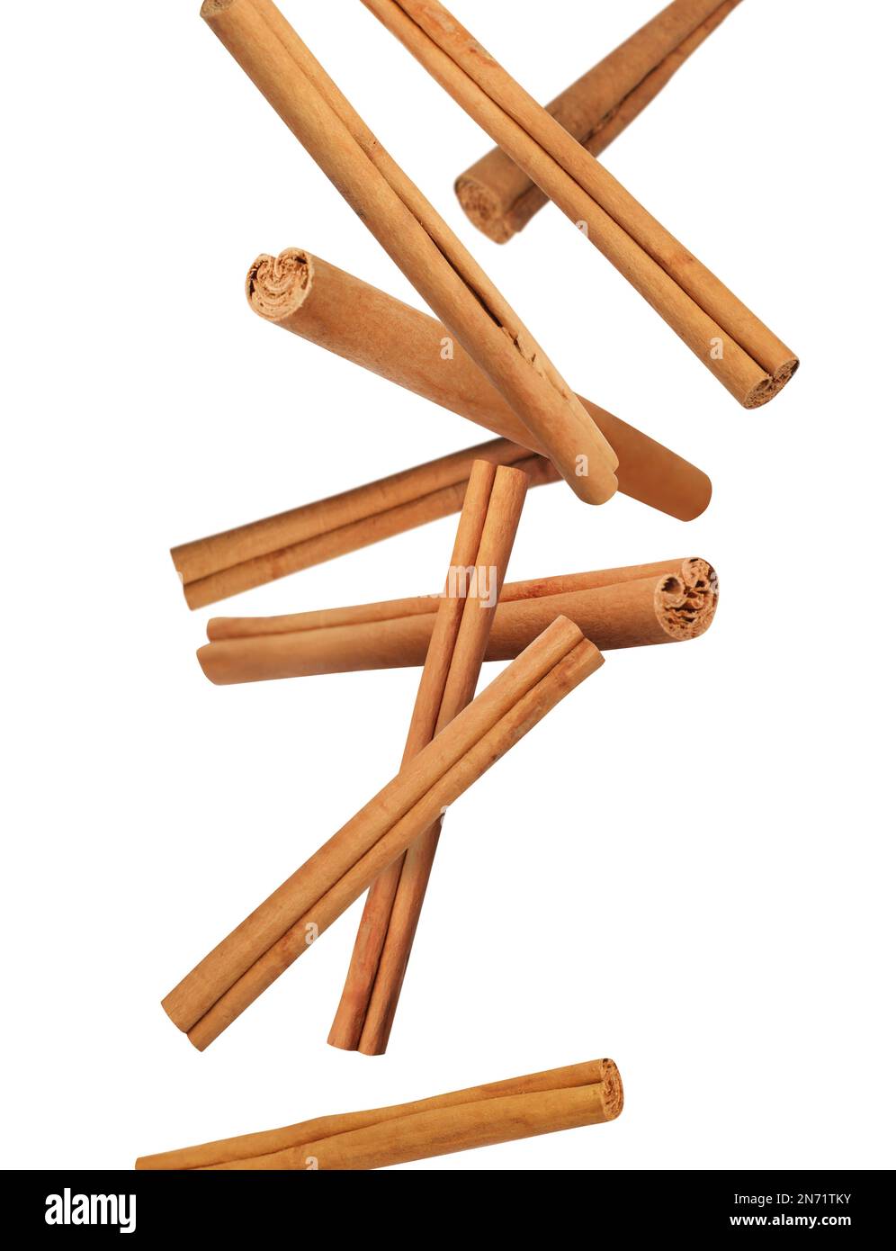 Aromatic cinnamon sticks falling on white background Stock Photo - Alamy