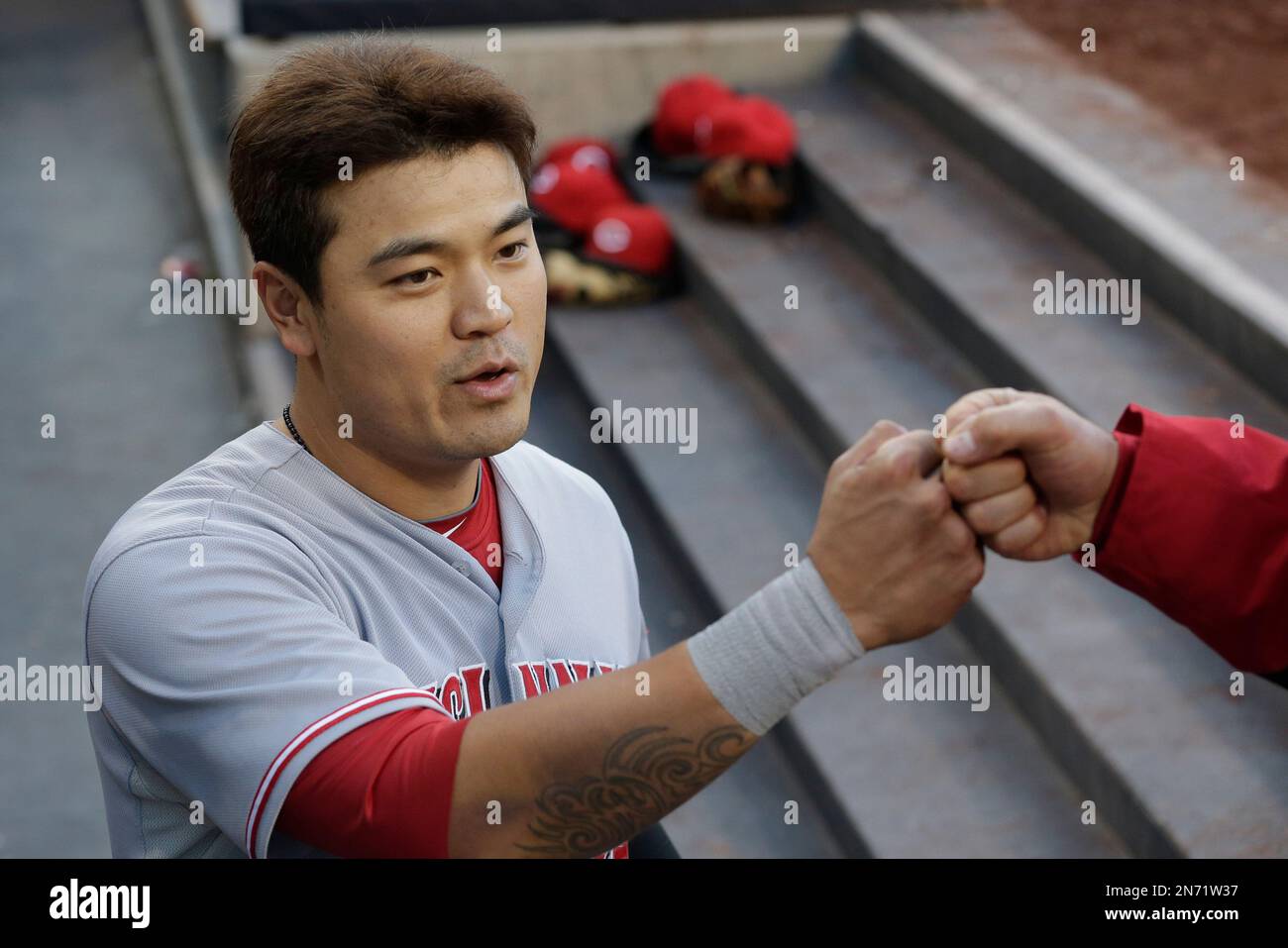 Cincinnati Reds center fielder Shin-Soo Choo, of South Korea, bumps ...