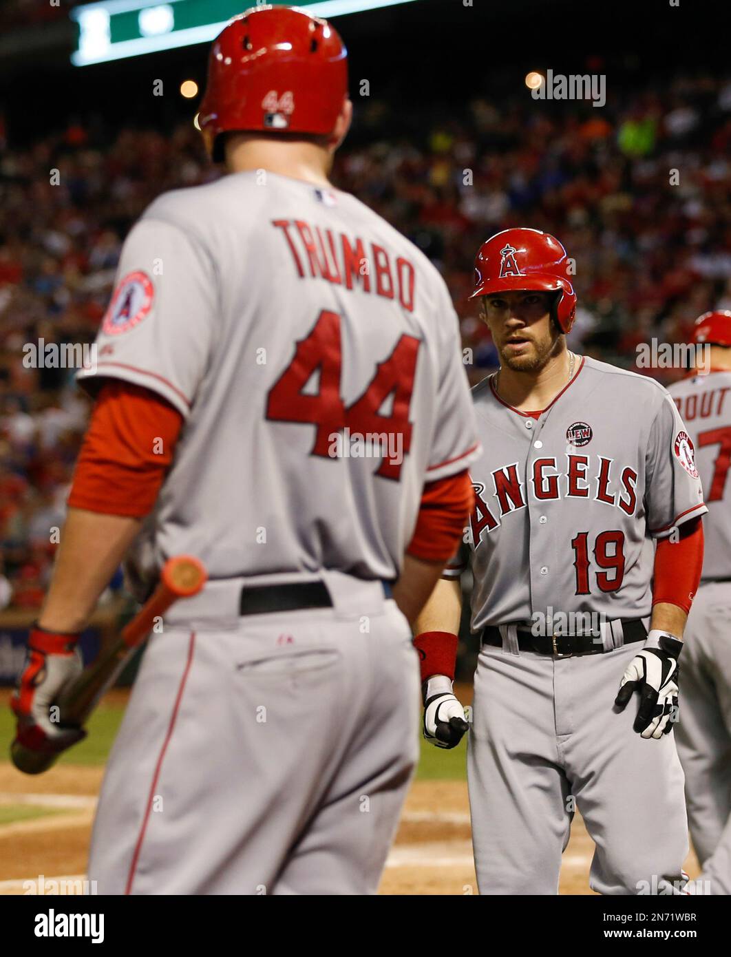 Los Angeles Angels' Collin Cowgill (19) is congratulated by Mark Trumbo ...