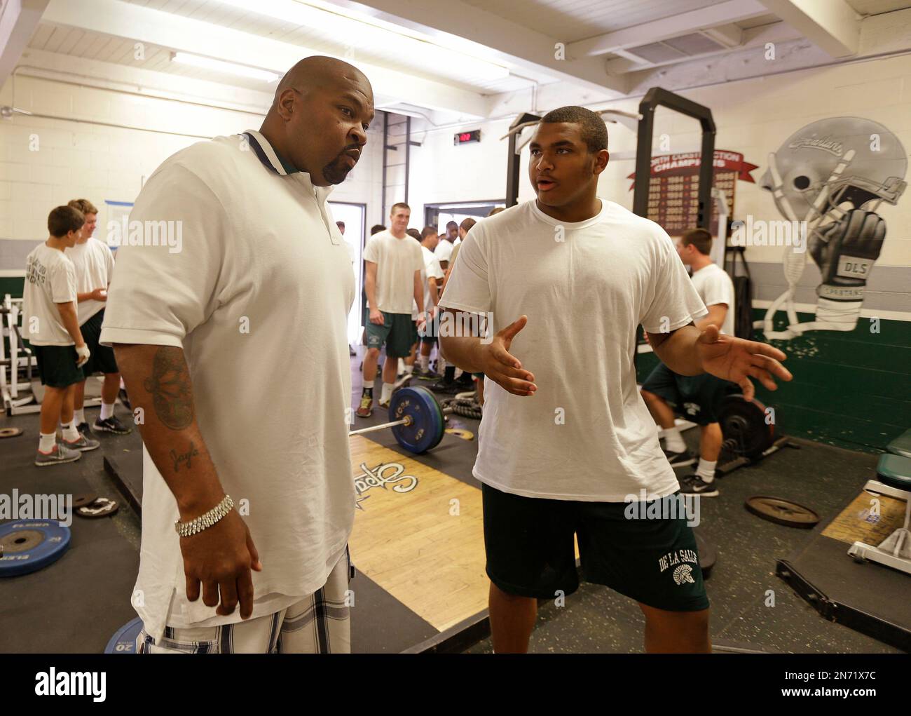 Dallas Cowboys Hall of Famer Larry Allen, left, helps his son, Larry ...