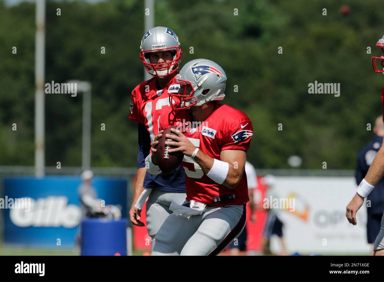 New England Patriots quarterback Tim Tebow and Tom Brady, rear, during ...