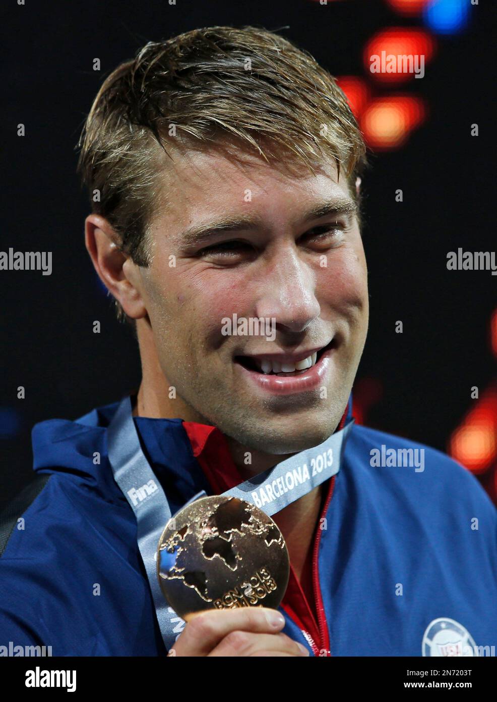 Matt Grevers of the United States, the gold medalist smiles as he holds ...