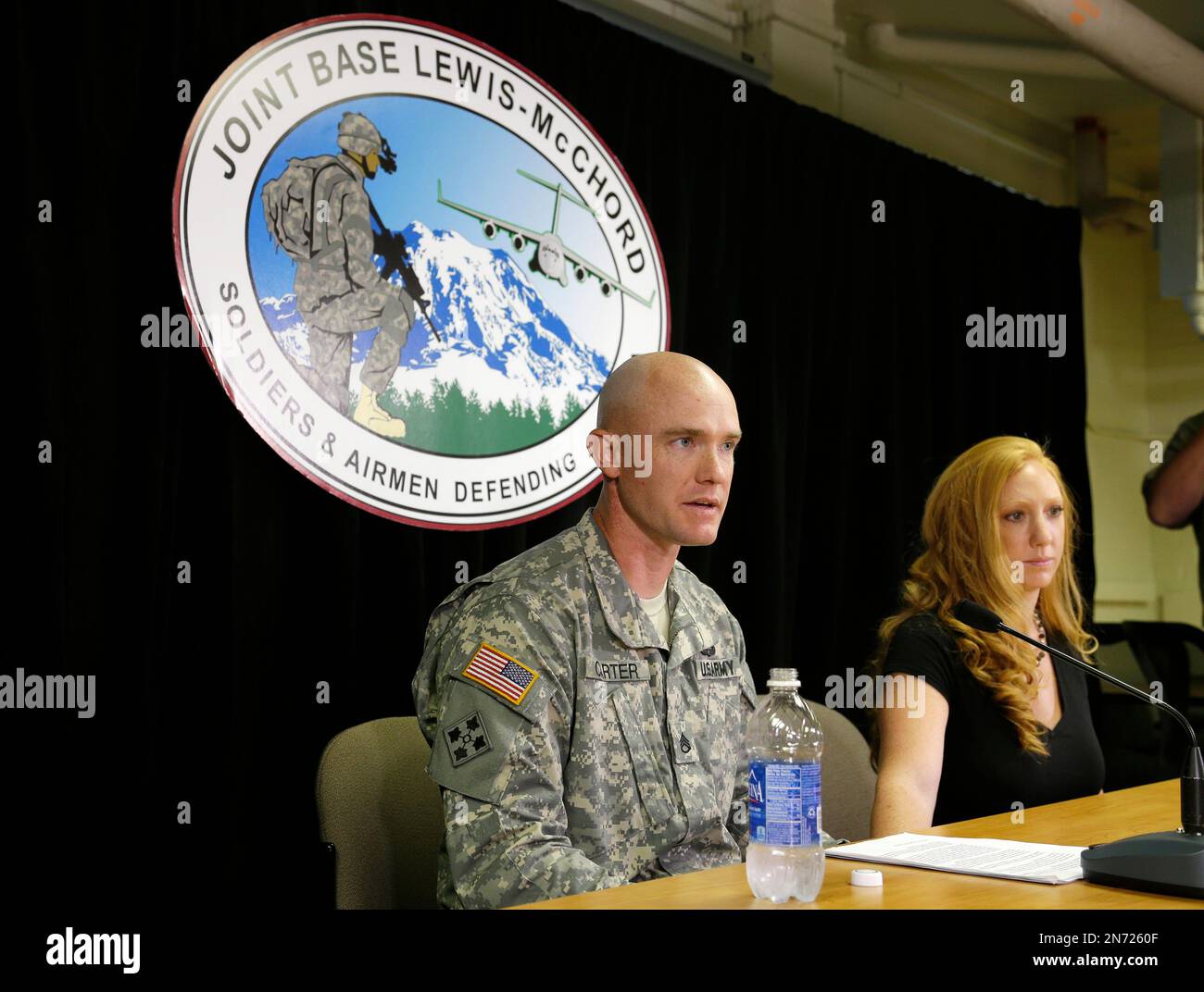 U.S. Army Staff Sgt. Ty Carter and his wife, Shannon Carter, talk to ...