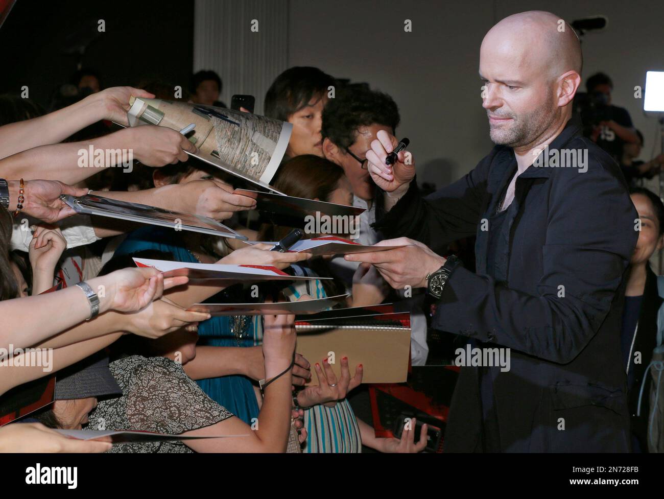 Director Marc Forster signs his autograph for a fan upon arrival for ...