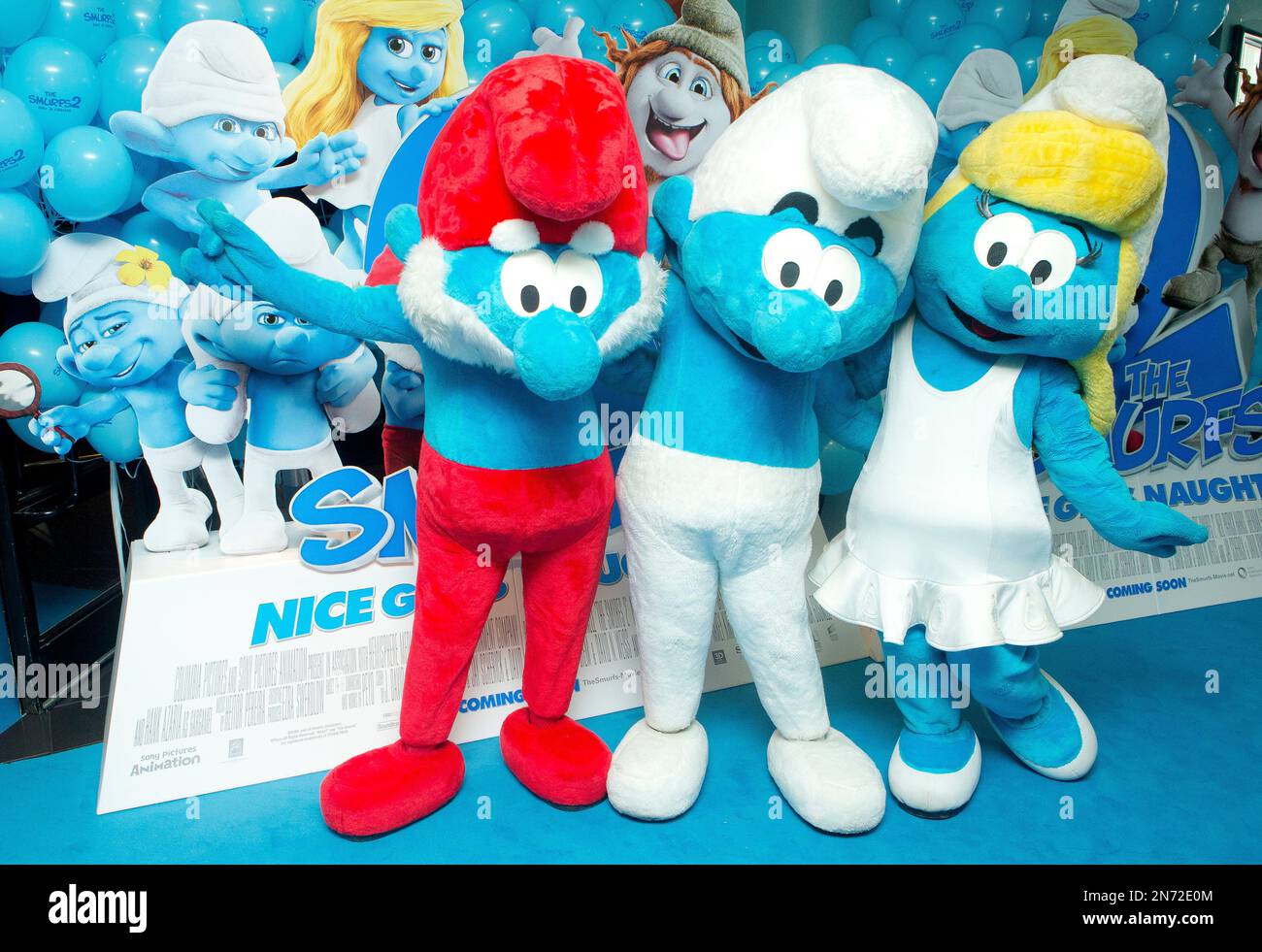 Three Smurf characters pose on the blue carpet for the UK premiere of ...