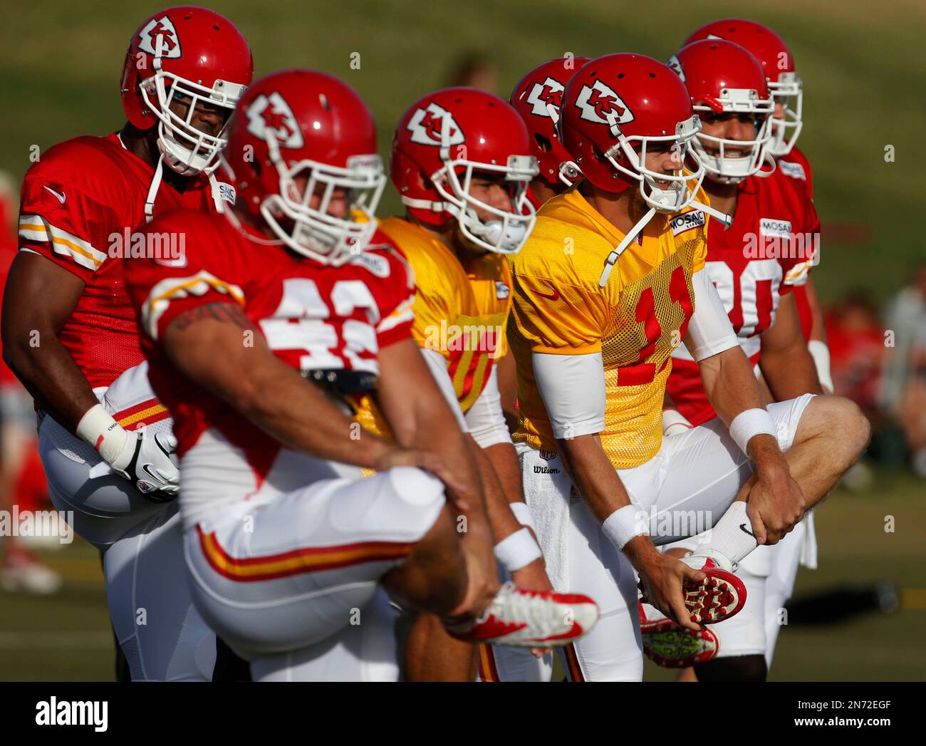 Kansas City Chiefs quarterback Alex Smith (11) stretches with other ...
