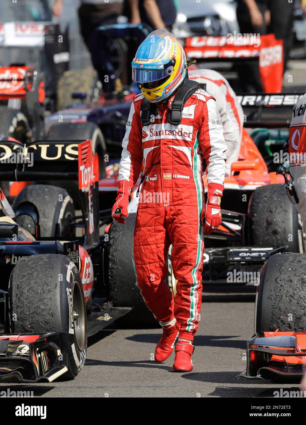 Ferrari driver Fernando Alonso of Spain watches cars at the end of the ...