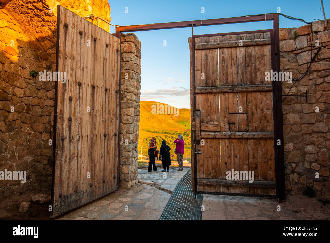 Old stone walls and wooden doors of structures at Takht-e Soleyman in ...