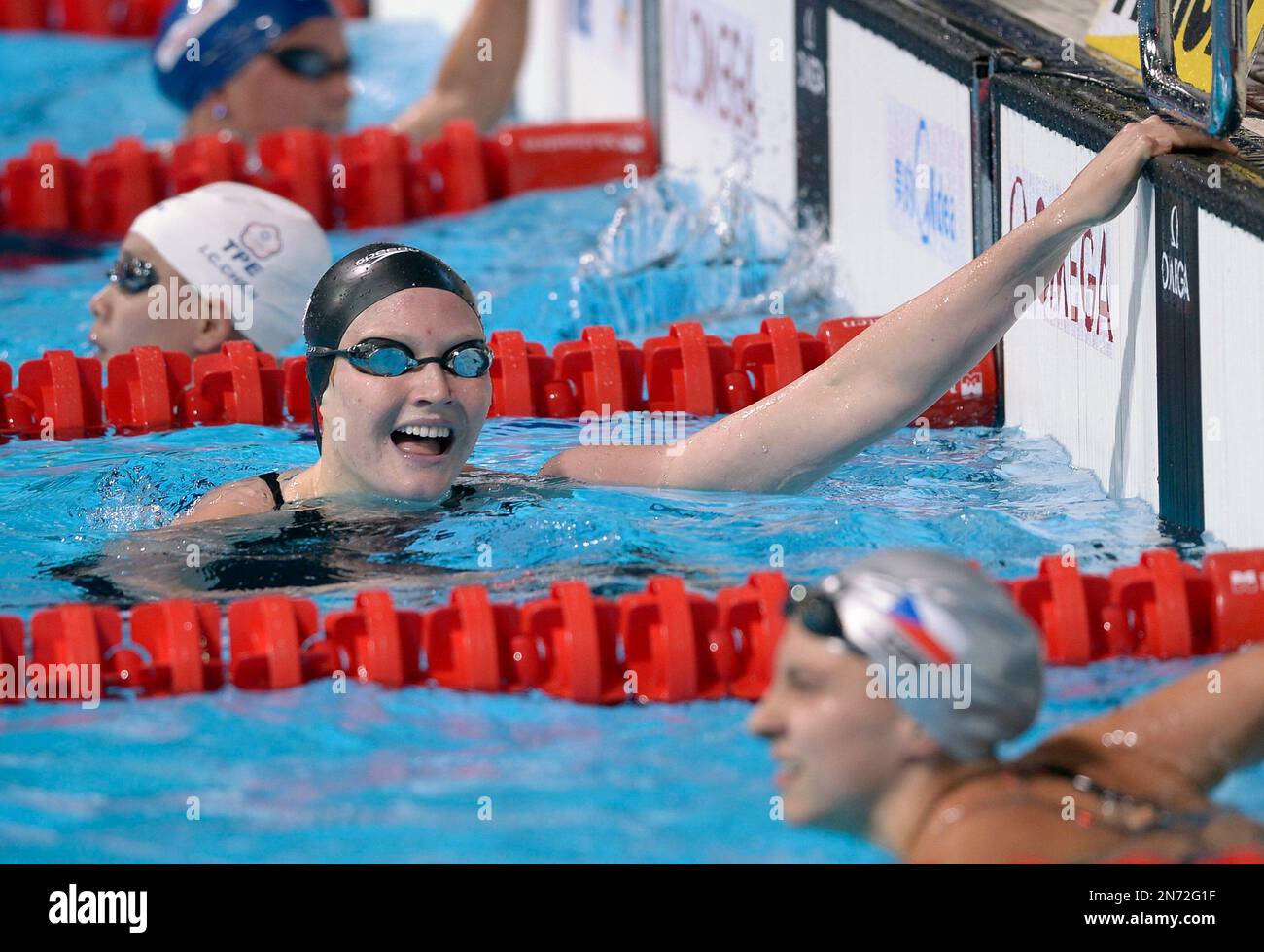 Mexico's Erica Dittmer Kane, centre, smiles after finishing a heat of ...
