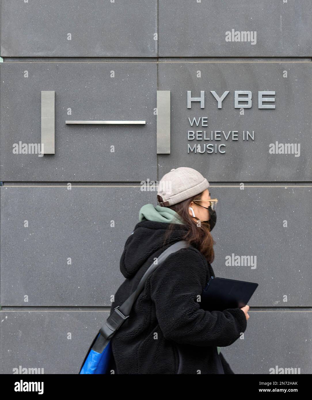 A woman walks past the Hybe headquarters building in Seoul. Hybe, the Korean entertainment ...
