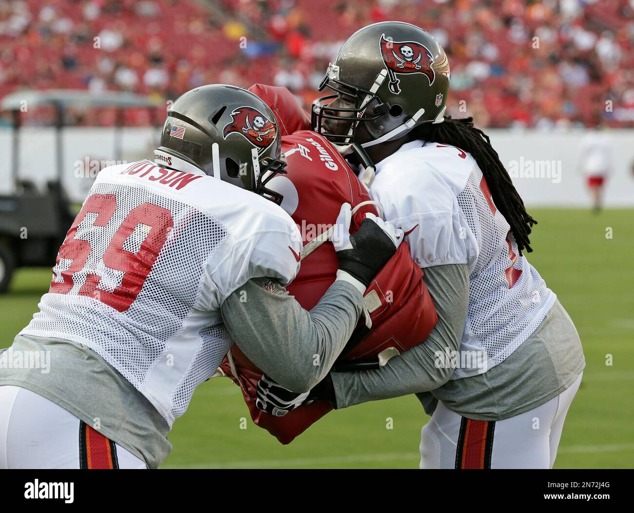 Tampa Bay Buccaneers guard Davin Joseph, right, blocks tackle Demar ...