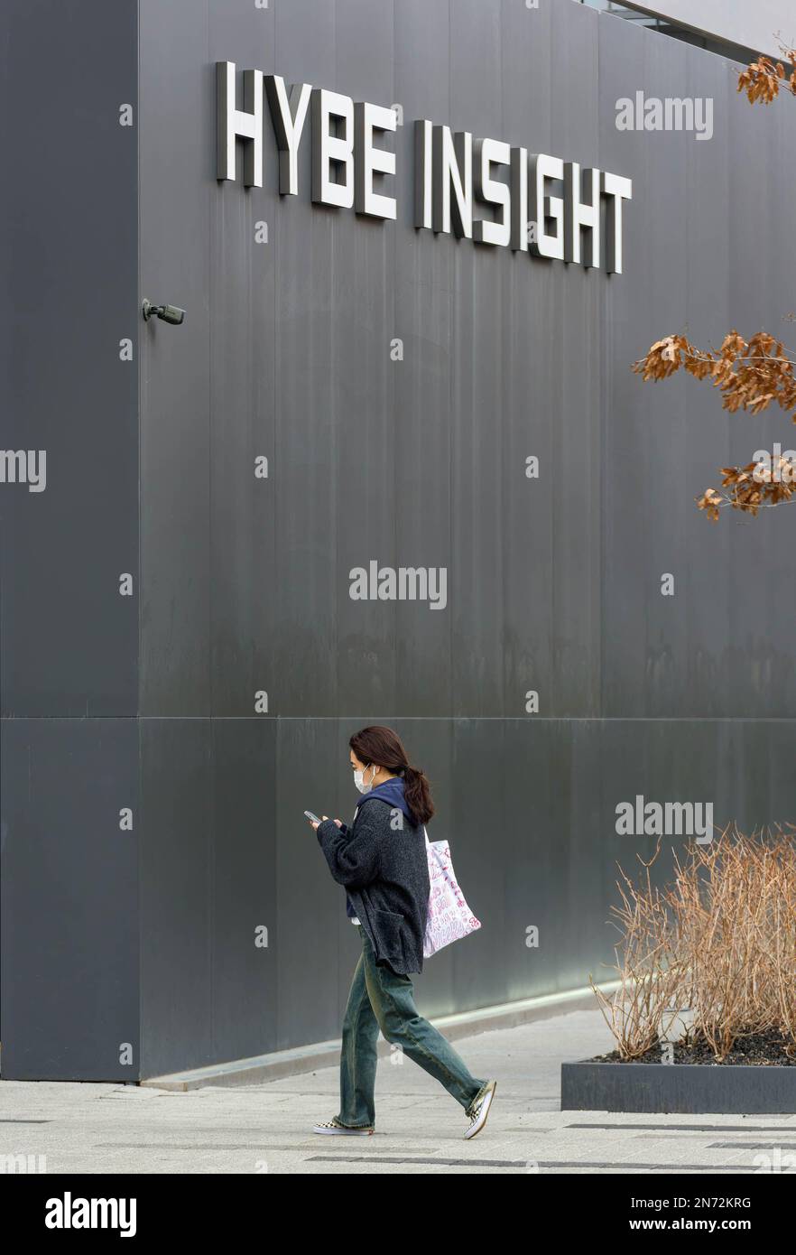Seoul, South Korea. 10th Feb, 2023. A woman walks past the Hybe headquarters building in Seoul ...