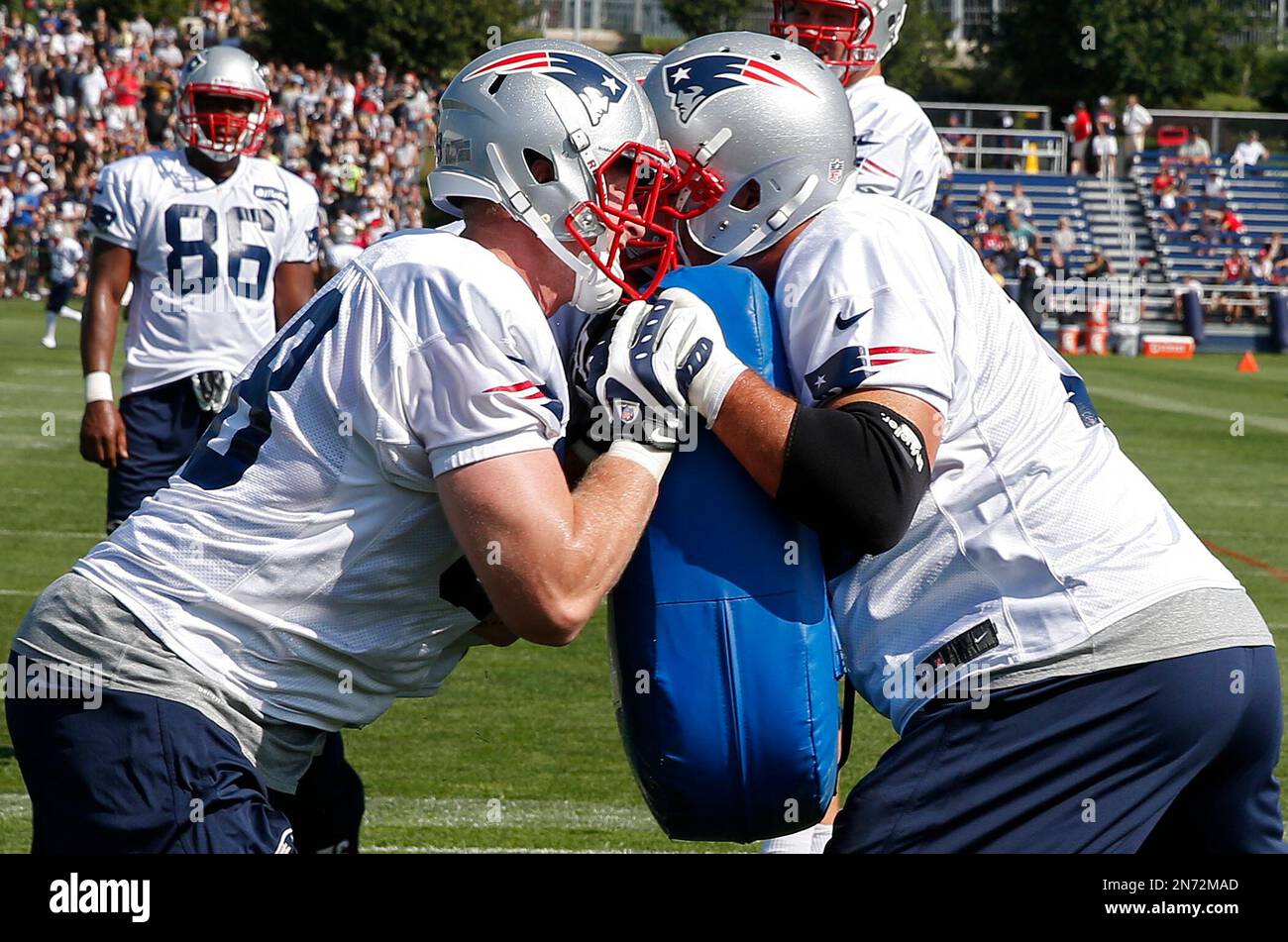 New England Patriots tight end Jake Ballard, center left, goes against ...