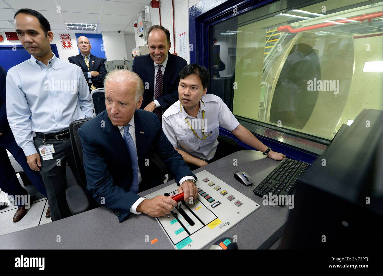 U.S. Vice President Joe Biden pushes a throttle to test a working ...