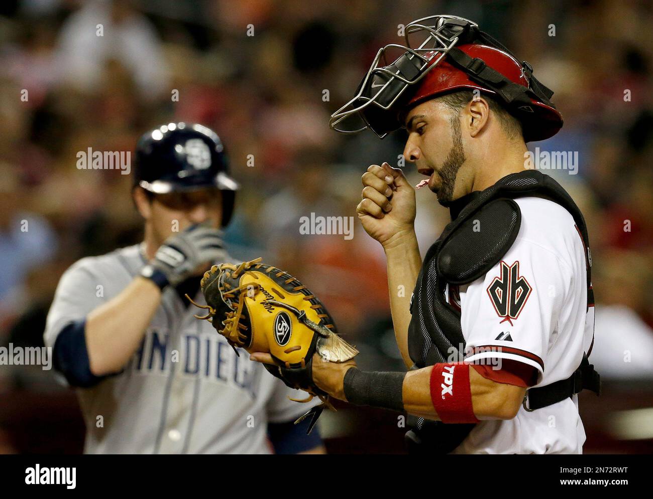 Arizona Diamondbacks' Wil Nieves, right, punches his glove as he walks ...