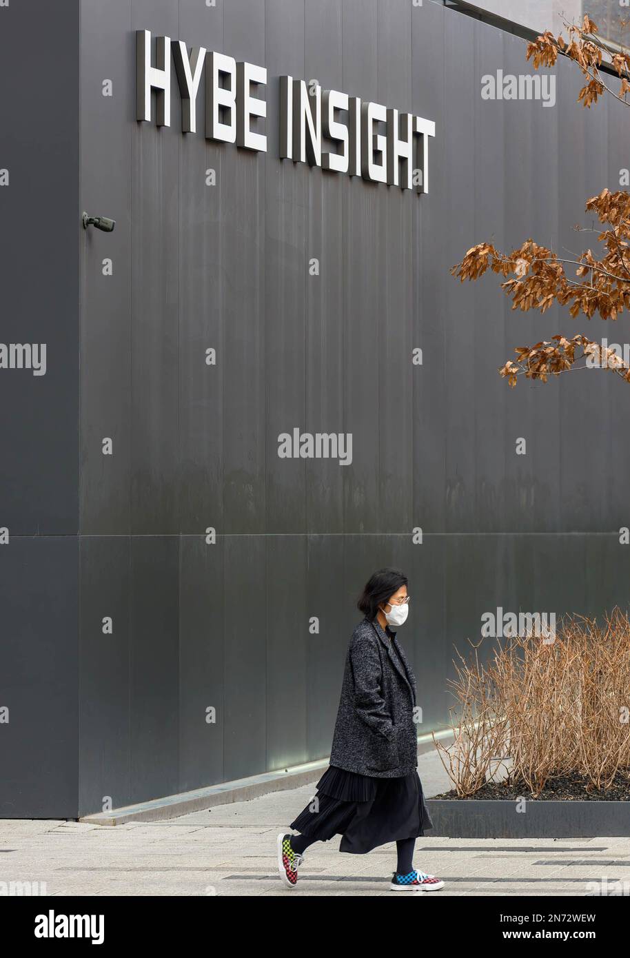 Seoul, South Korea. 10th Feb, 2023. A woman walks past the Hybe headquarters building in Seoul ...