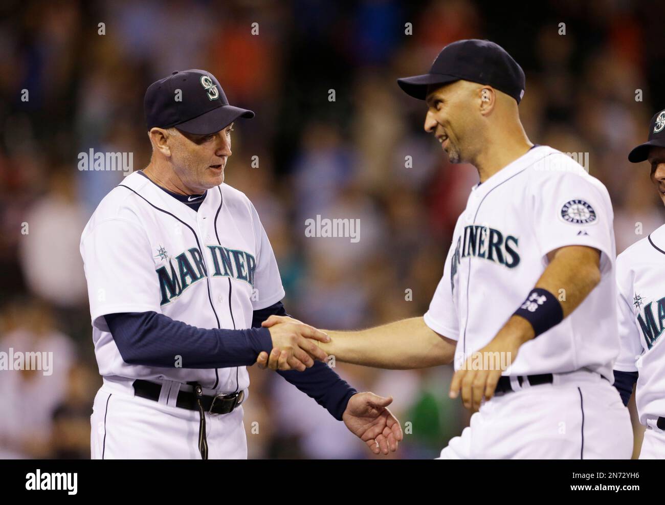 Seattle Mariners bench coach Robby Thompson, left, congratulates Raul ...