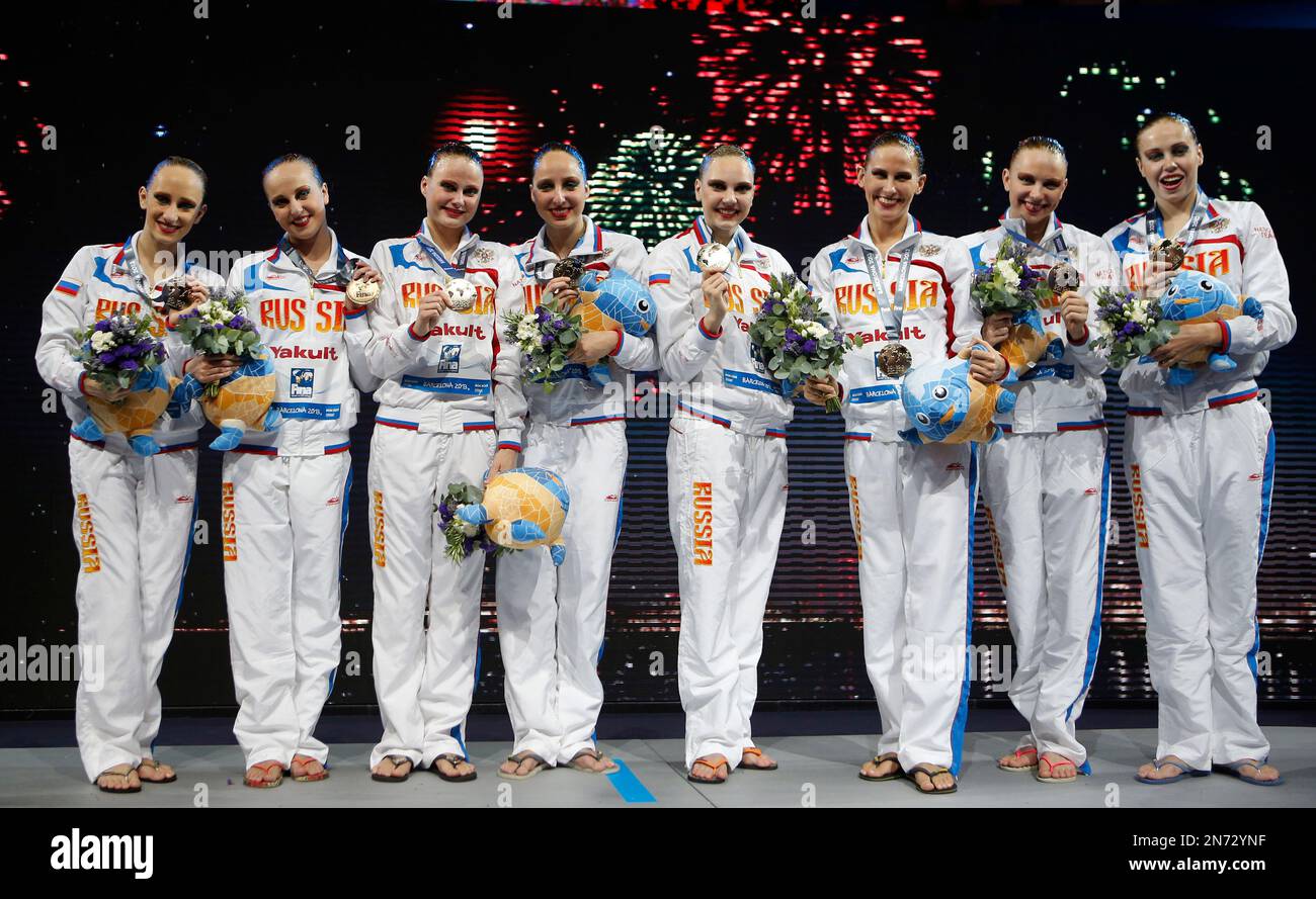 The Russian team hold up their gold medals after winning the ...