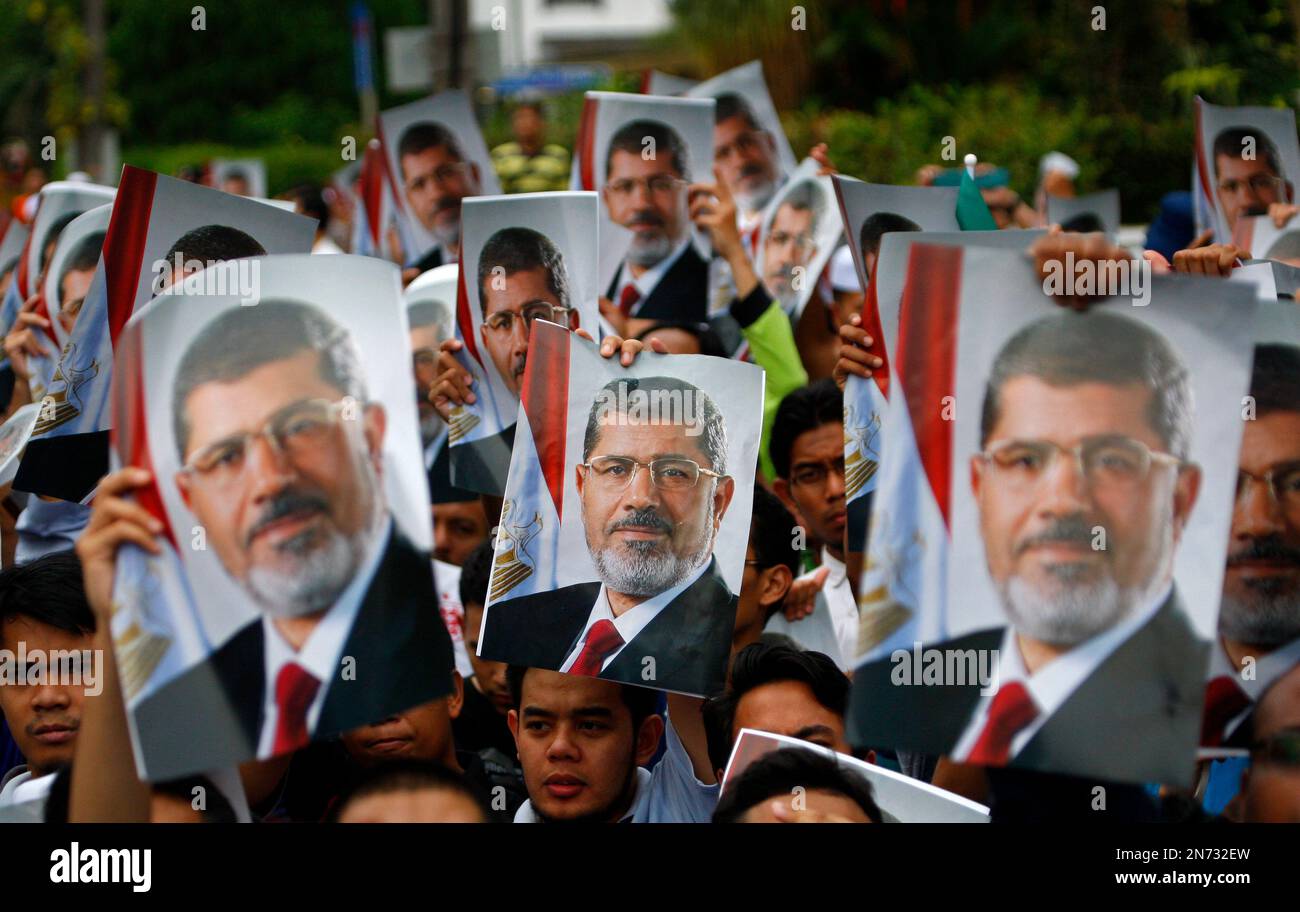 Muslim protesters display posters of Egypt's ousted President Mohammed ...